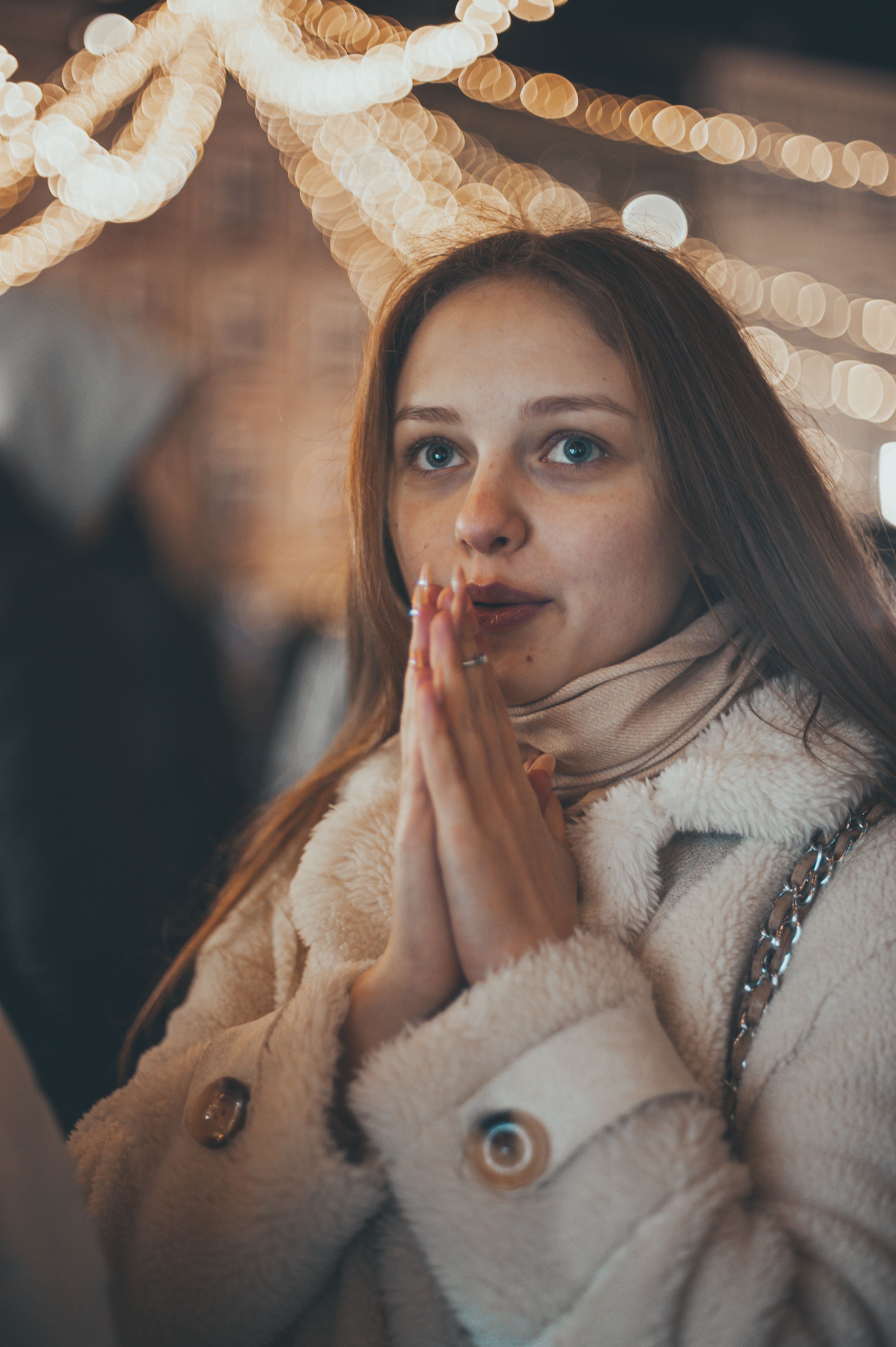Woman in Coat with Hands Together · Free Stock Photo