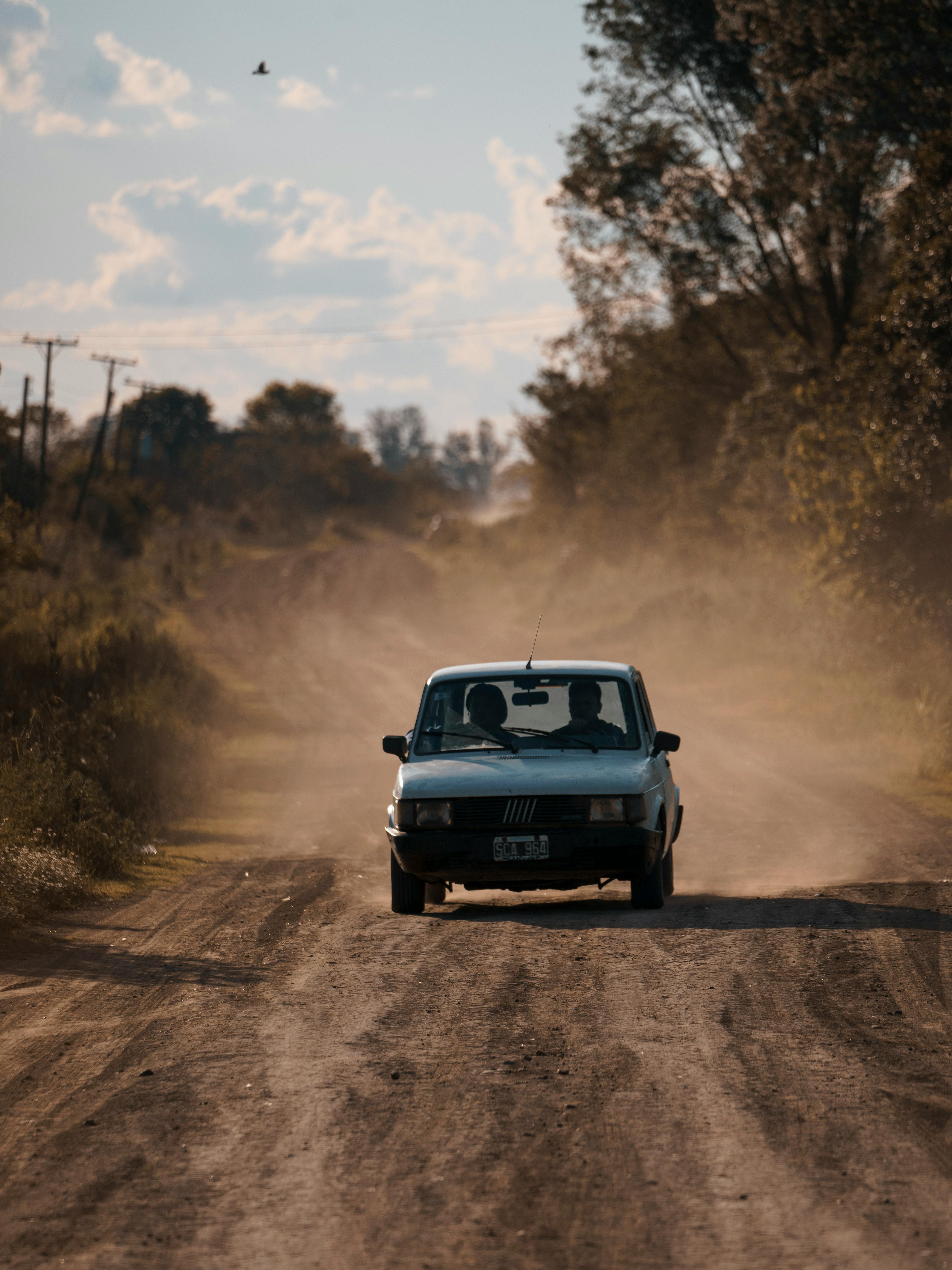 White Car Driving on Dirt Road · Free Stock Photo