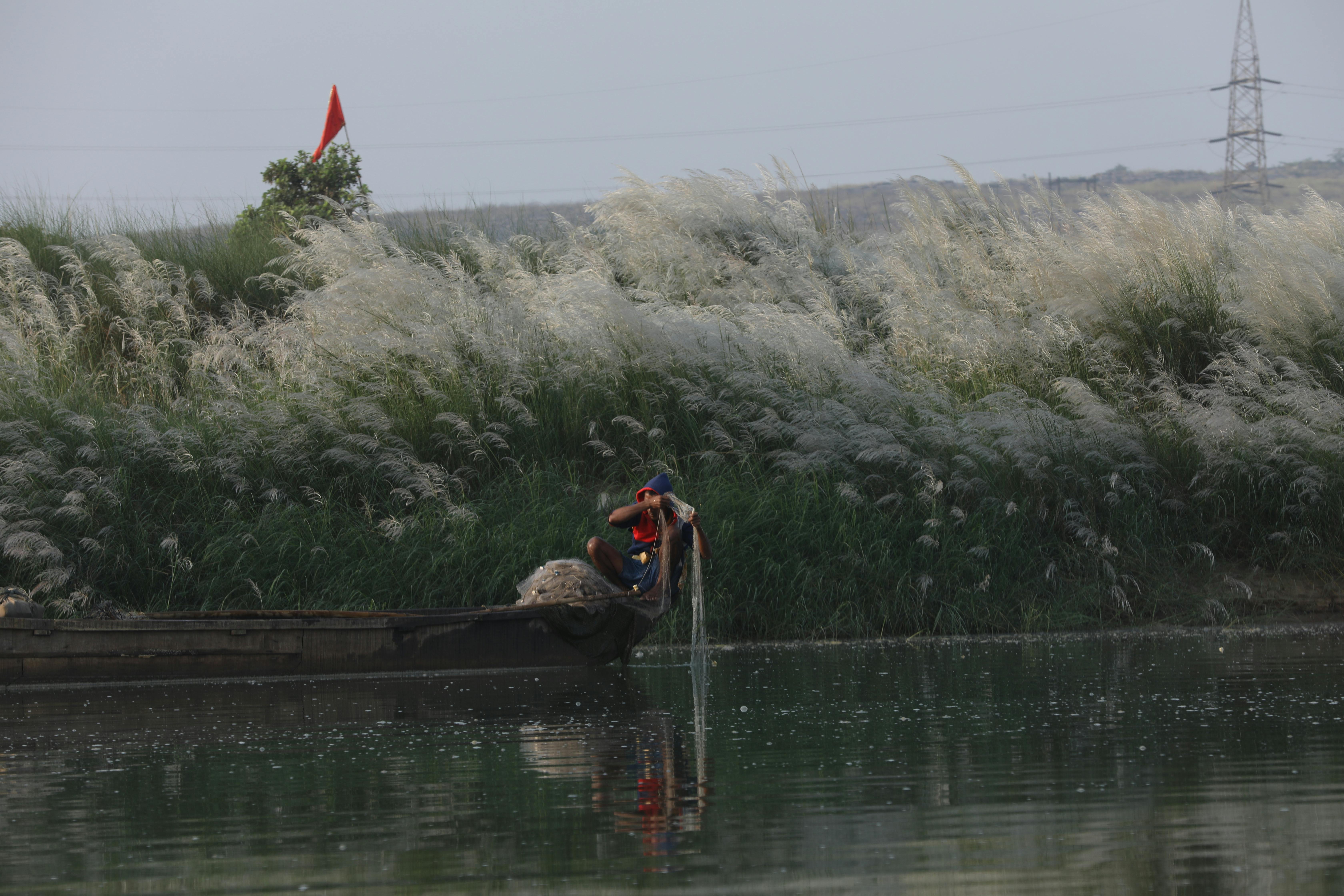 Grayscale Photo of Man Throwing a Fishing Net · Free Stock Photo