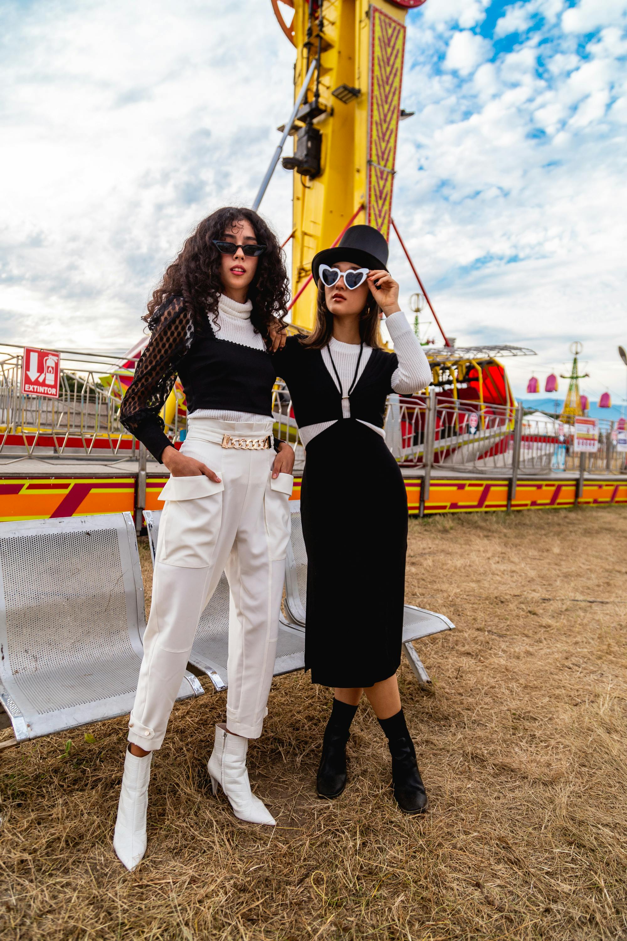 Women Posing Beside Carnival Rides · Free Stock Photo