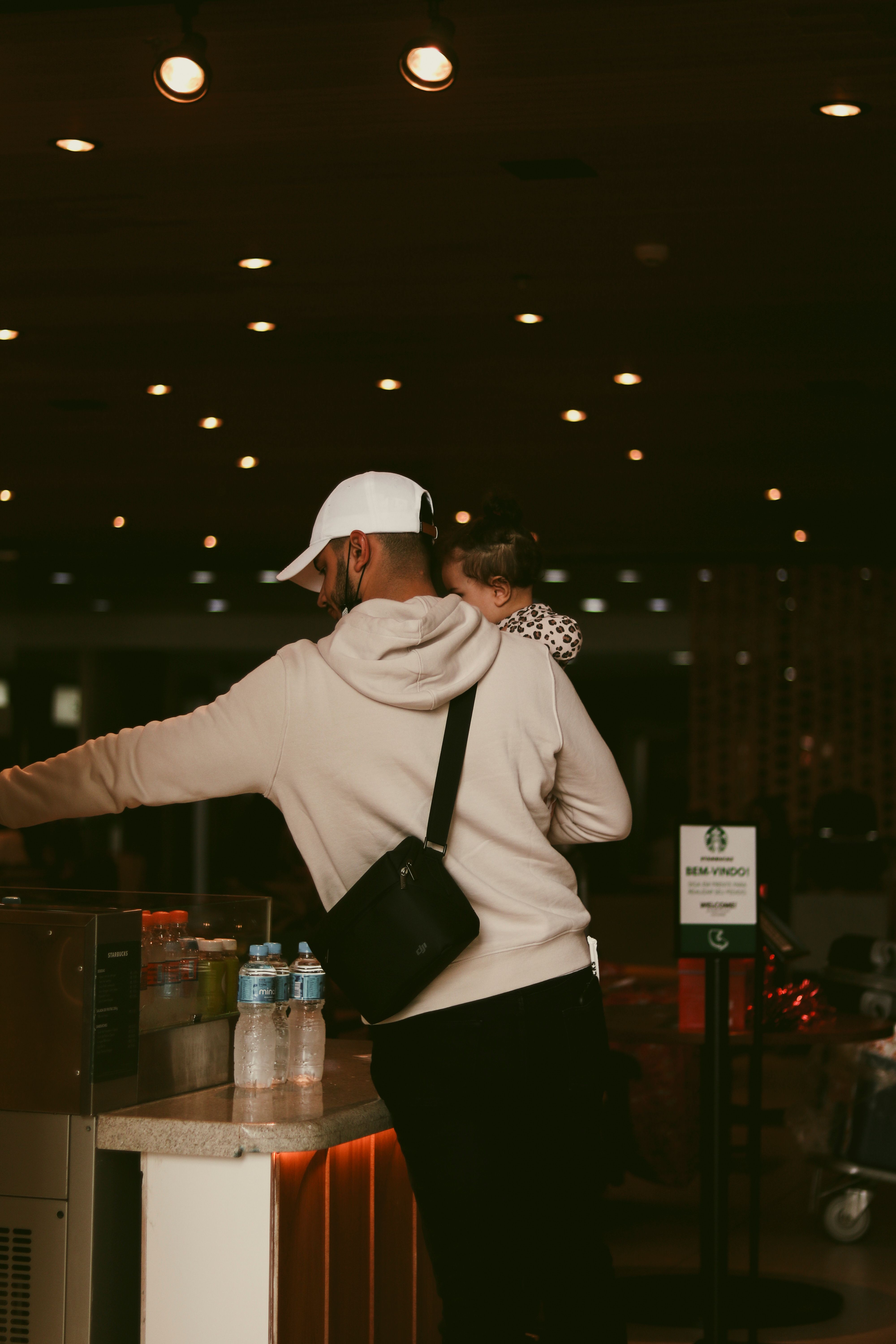 A Family Walking Inside the House while Carrying Boxes · Free Stock Photo