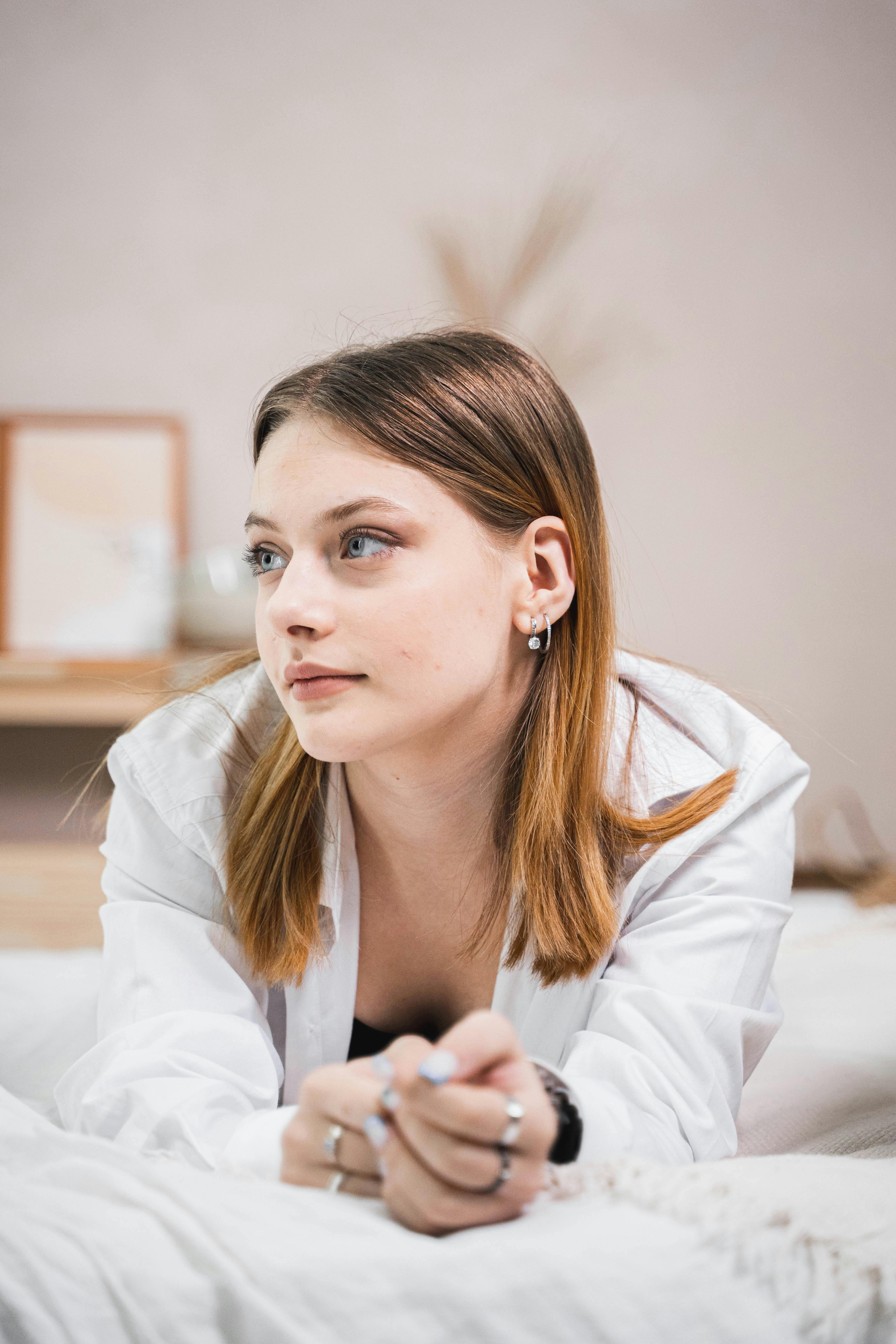 Close-Up Shot of a Girl in White Shirt Pouting · Free Stock Photo