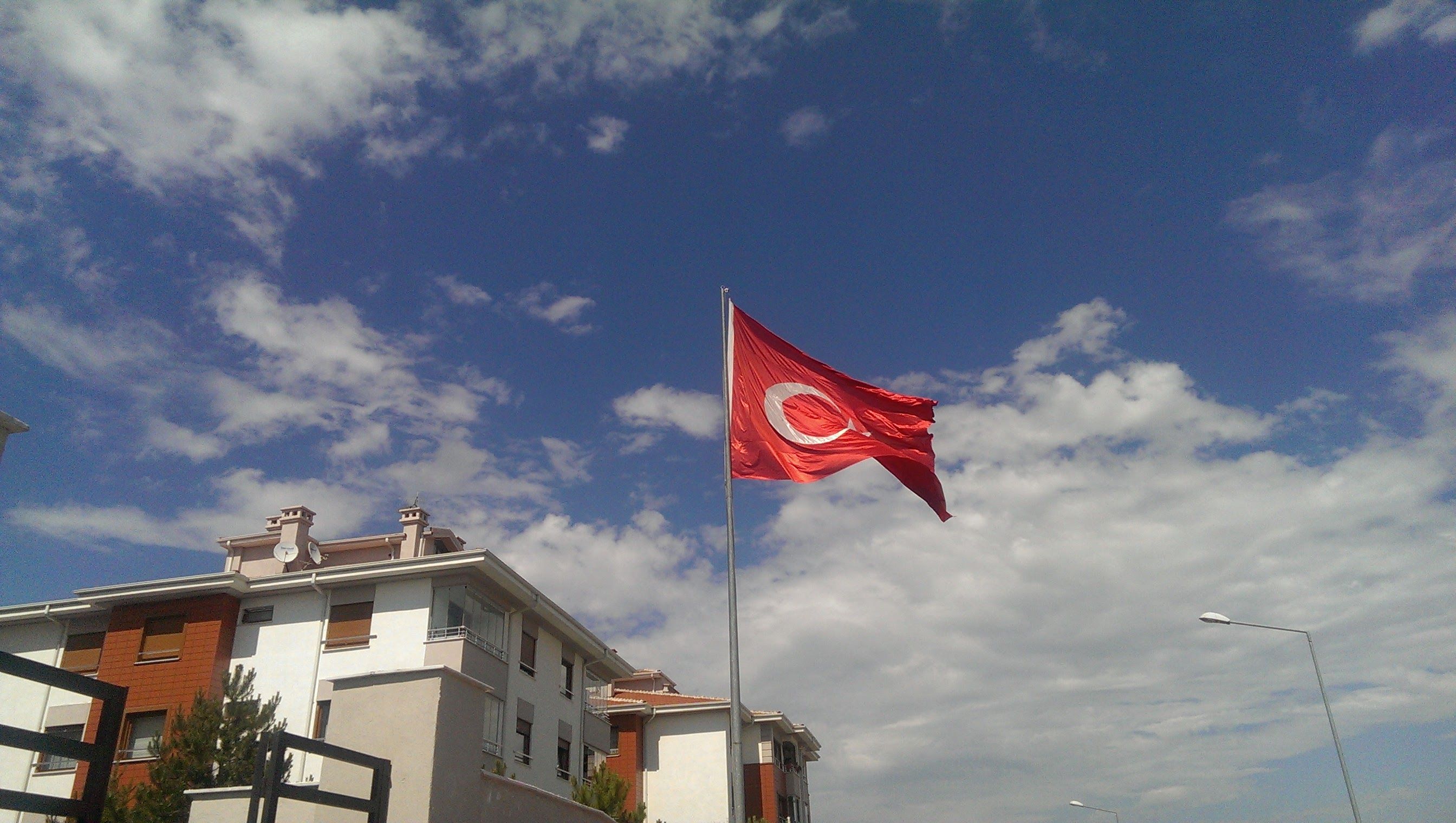 Turkey Flag on Top of Pole Near Brown Concrete Building Under Blue Sky ...
