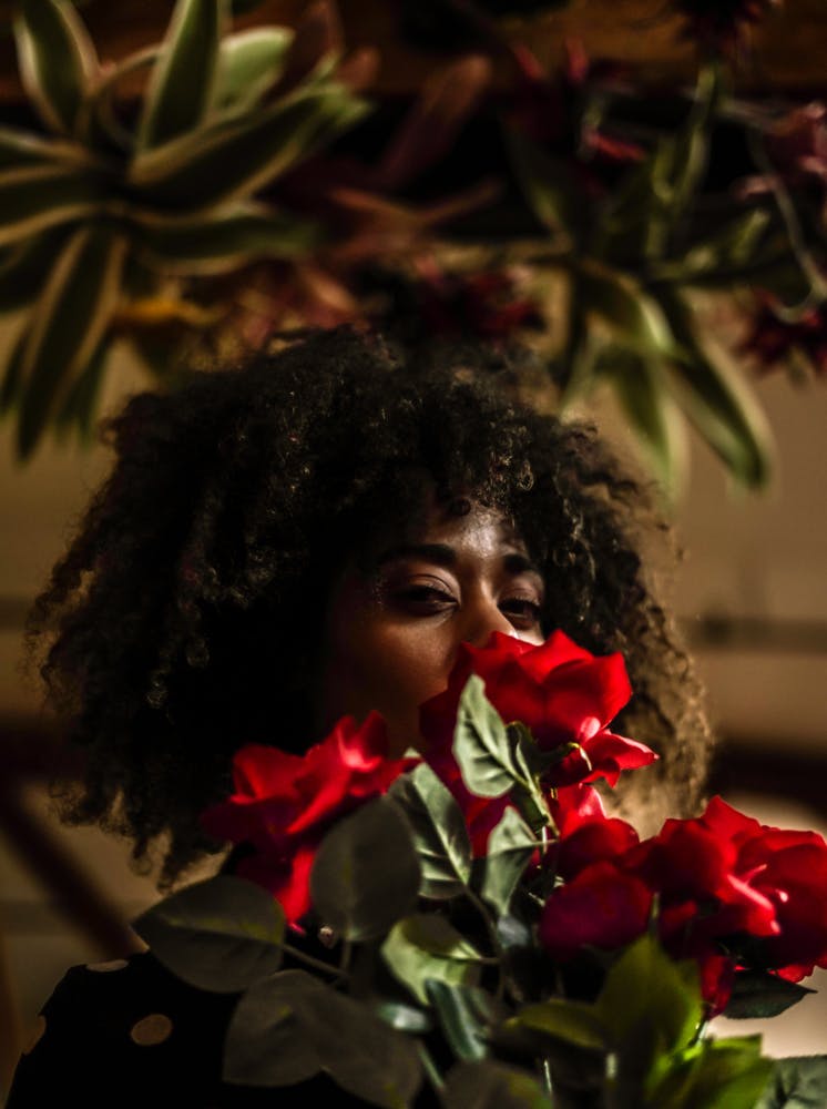 Woman Behind Red Flowers · Free Stock Photo
