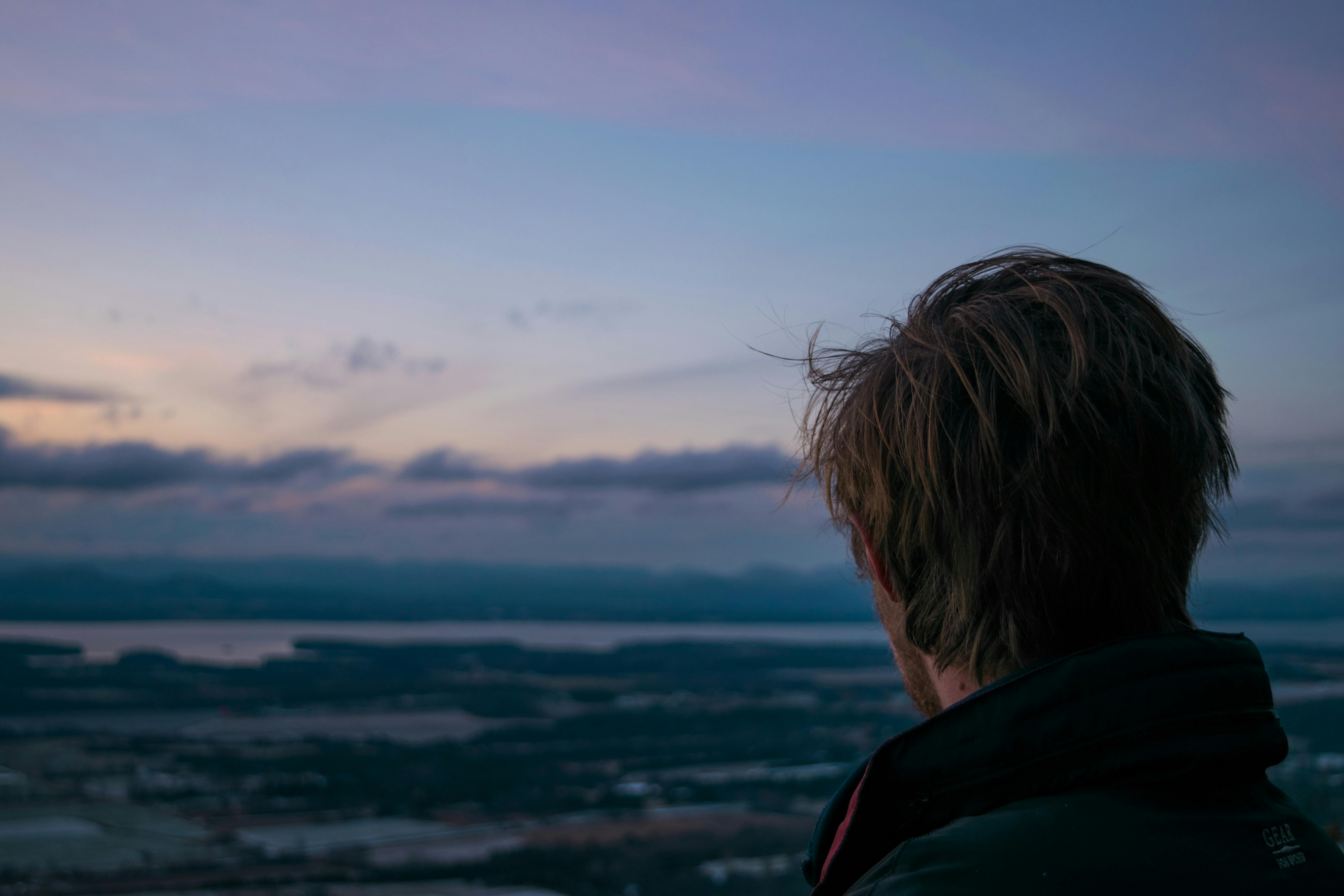 Man Looking Back at Bagpack on Pink Background · Free Stock Photo