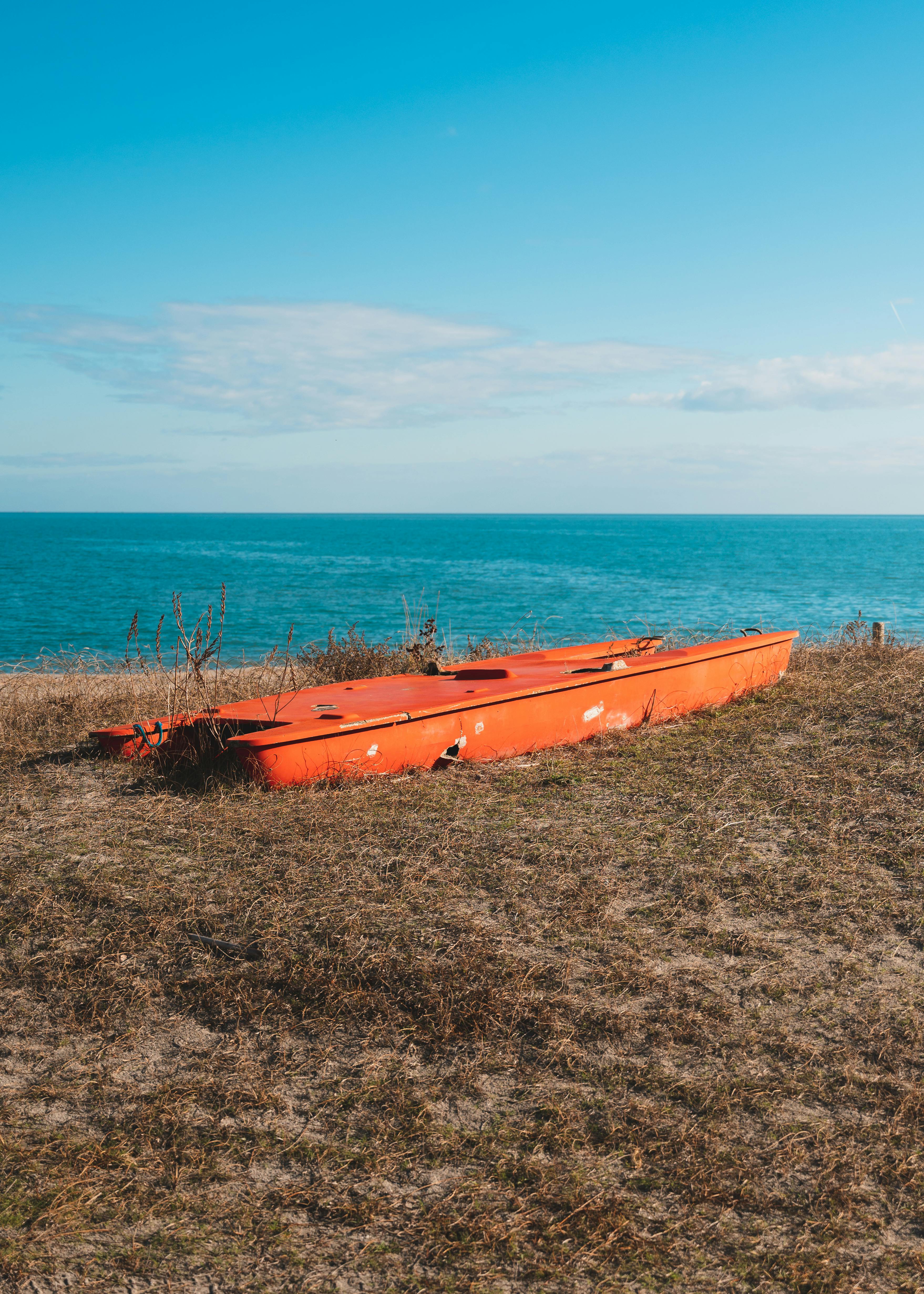 An Orange Boat on Seashore · Free Stock Photo