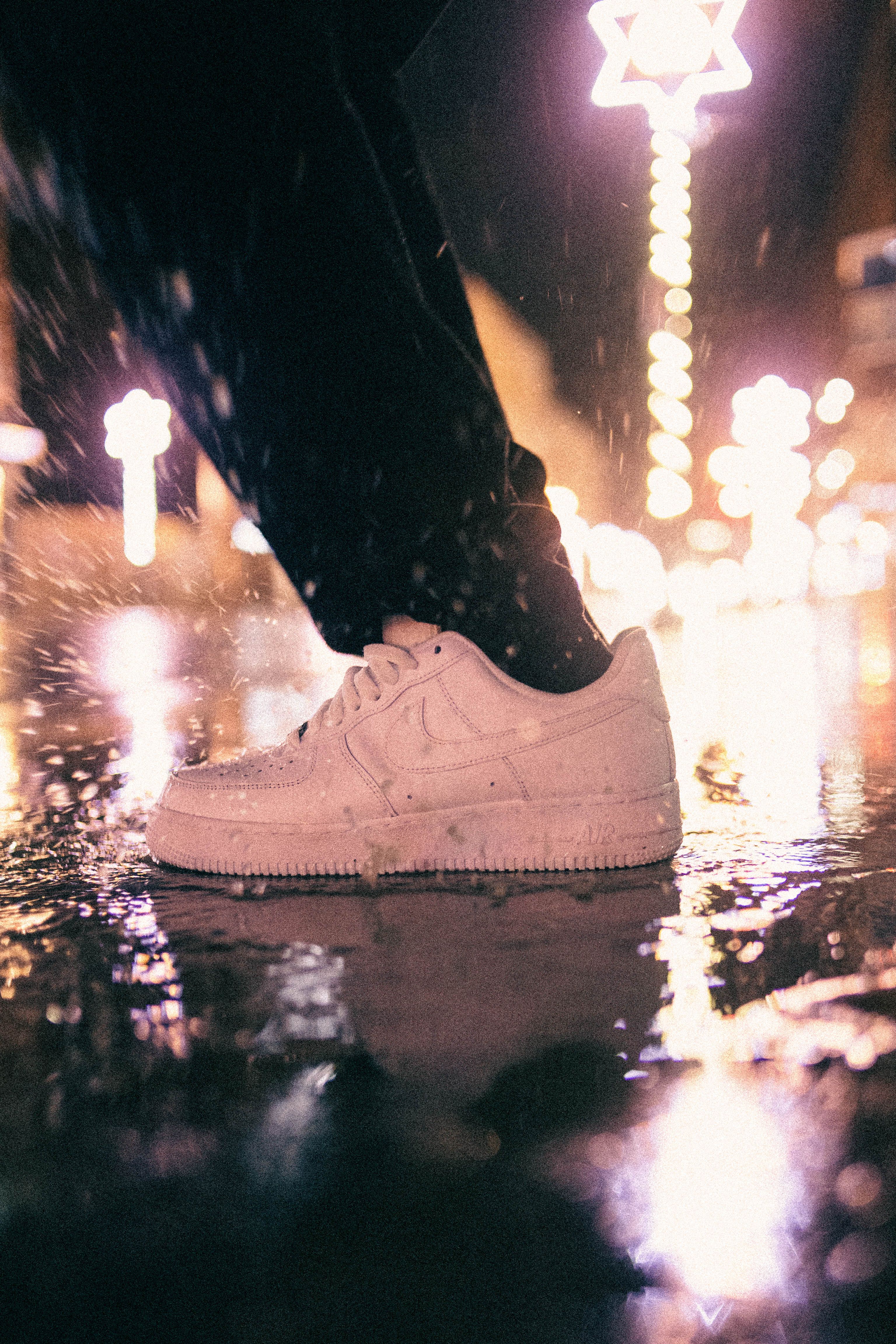 Man in Sneakers Splashing in Puddle at Night · Free Stock Photo