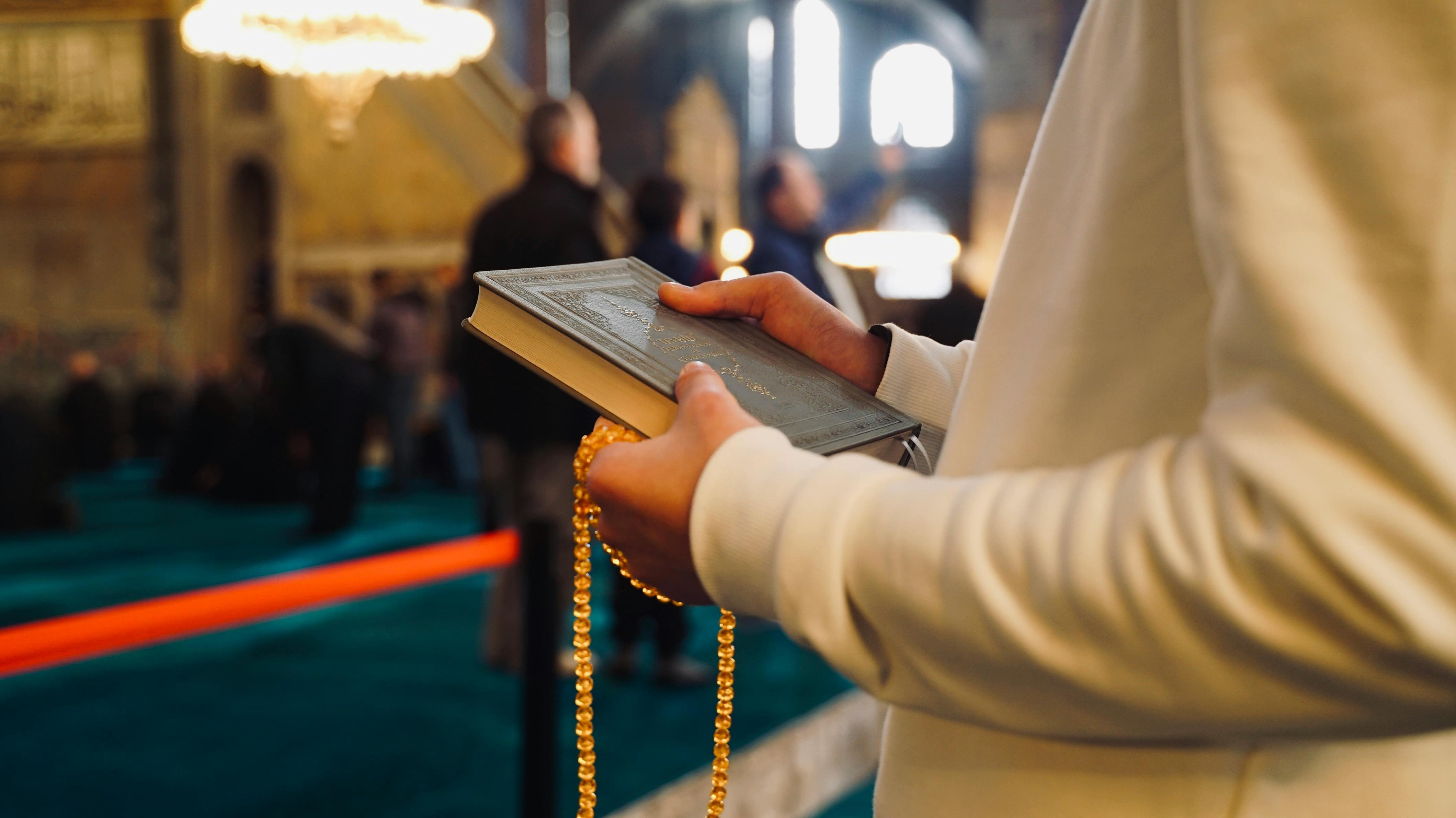 Opened religious book on stone desk in mosque backyard · Free Stock Photo