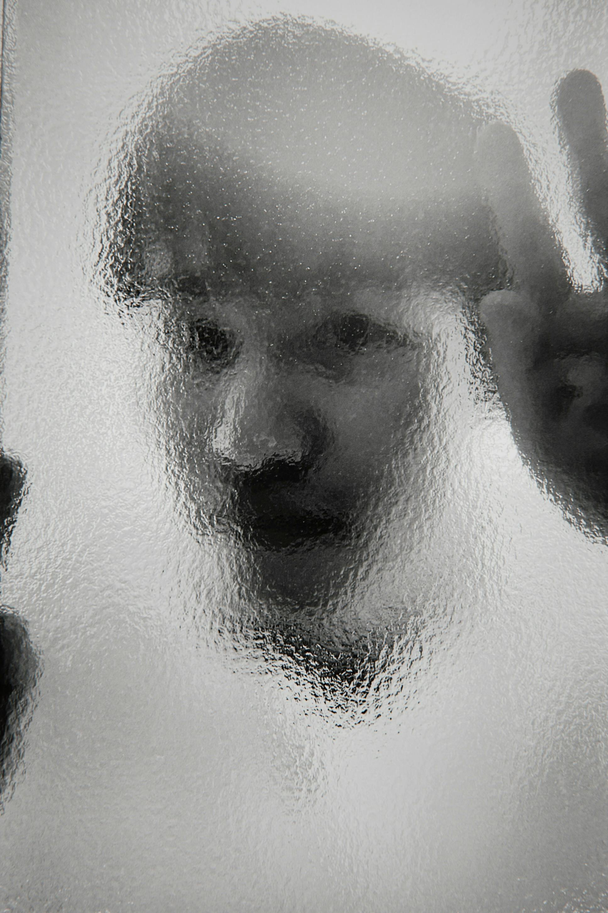 A Person Behind a Frosted Glass · Free Stock Photo