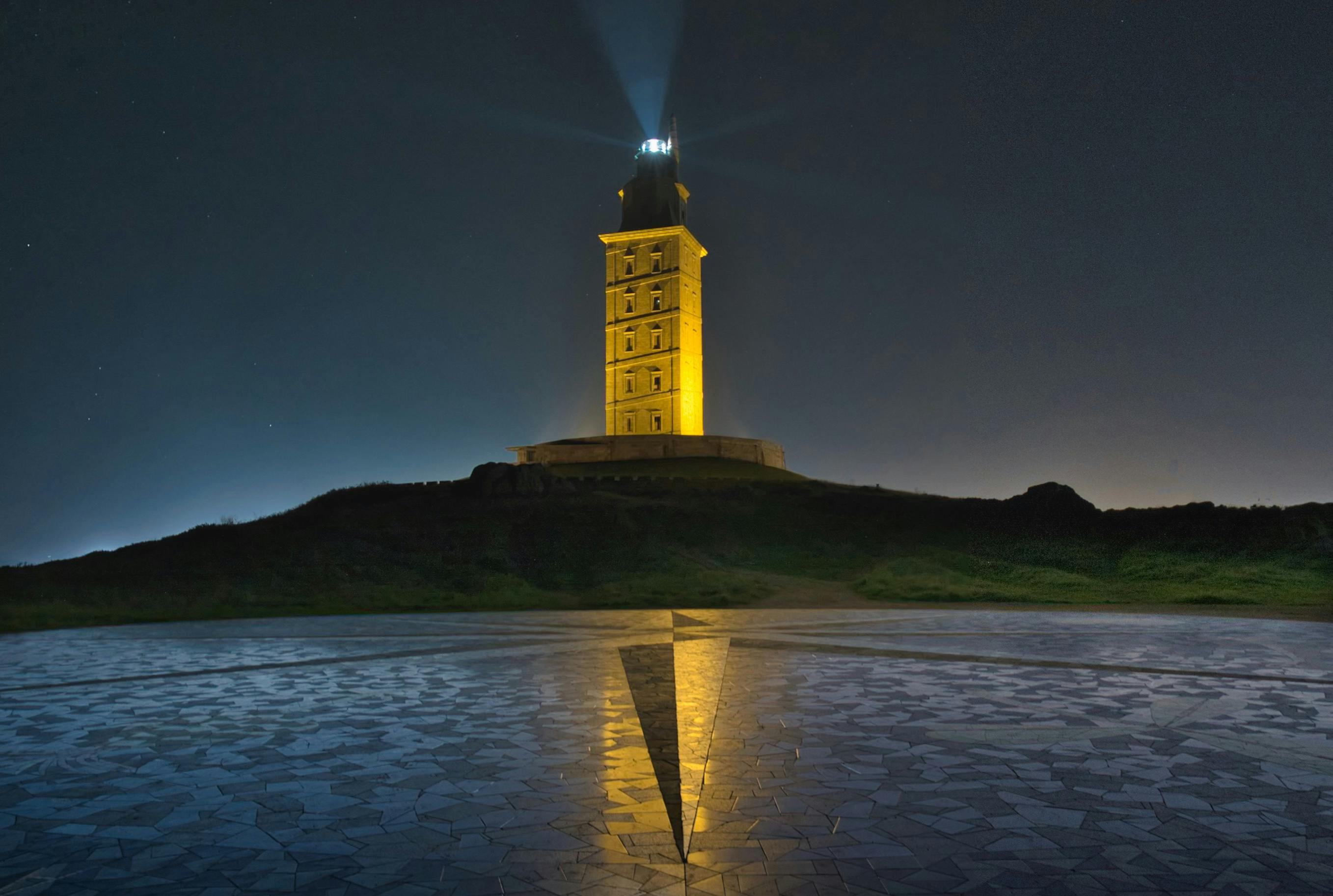 Lighthouse on Hill at Night · Free Stock Photo