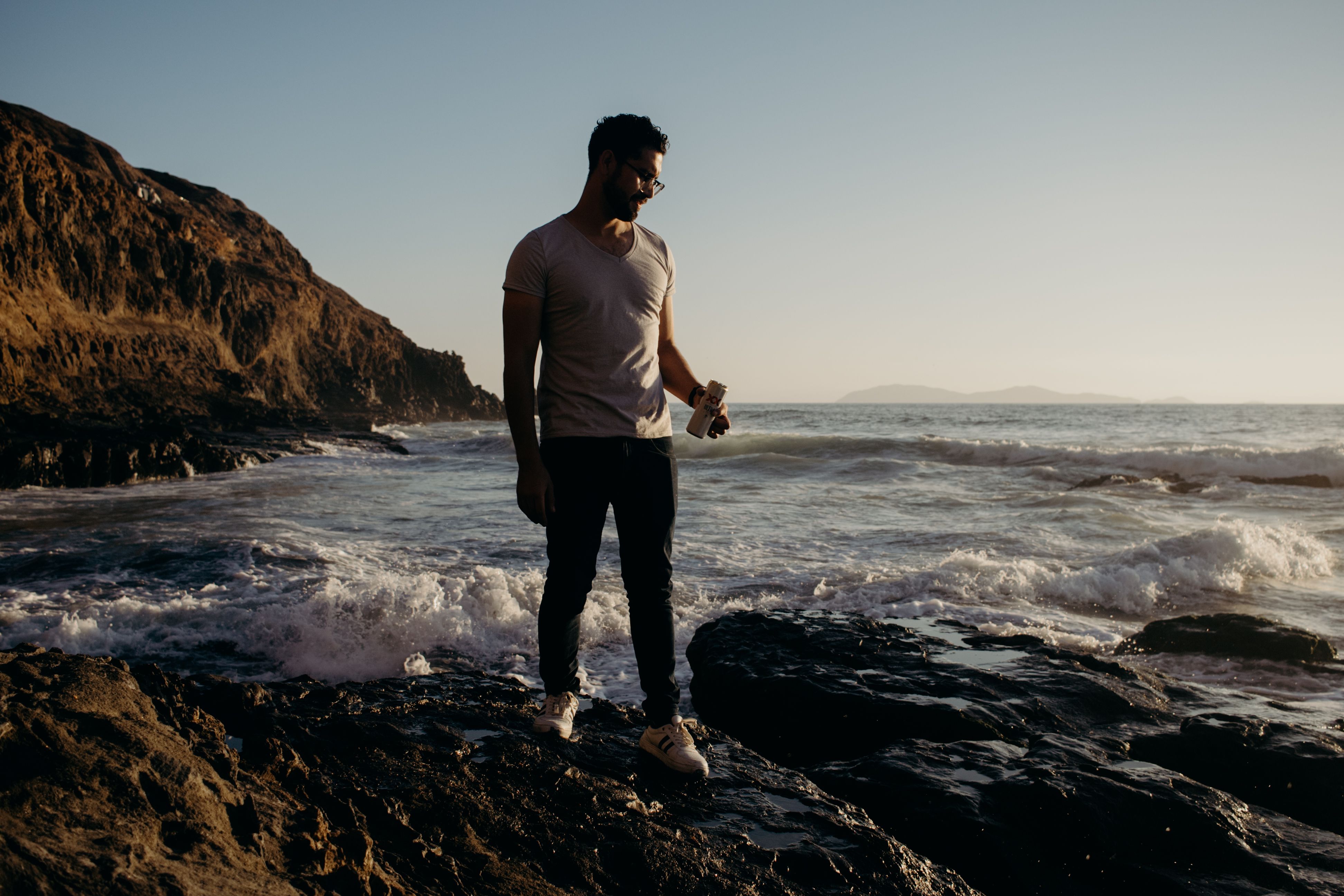 Men Standing on Rocks near the Ocean · Free Stock Photo