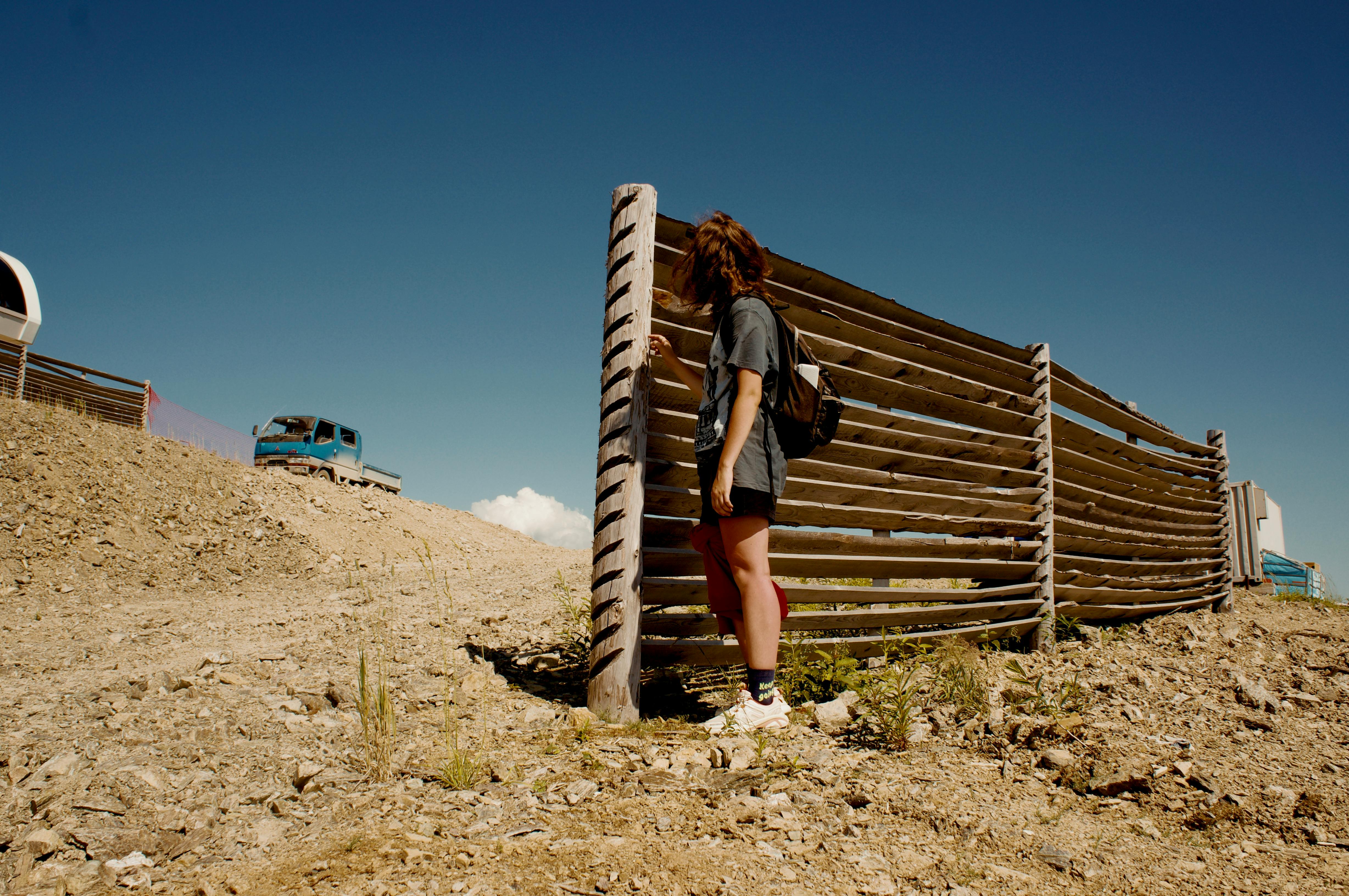 Person Standing near Wooden Fence · Free Stock Photo