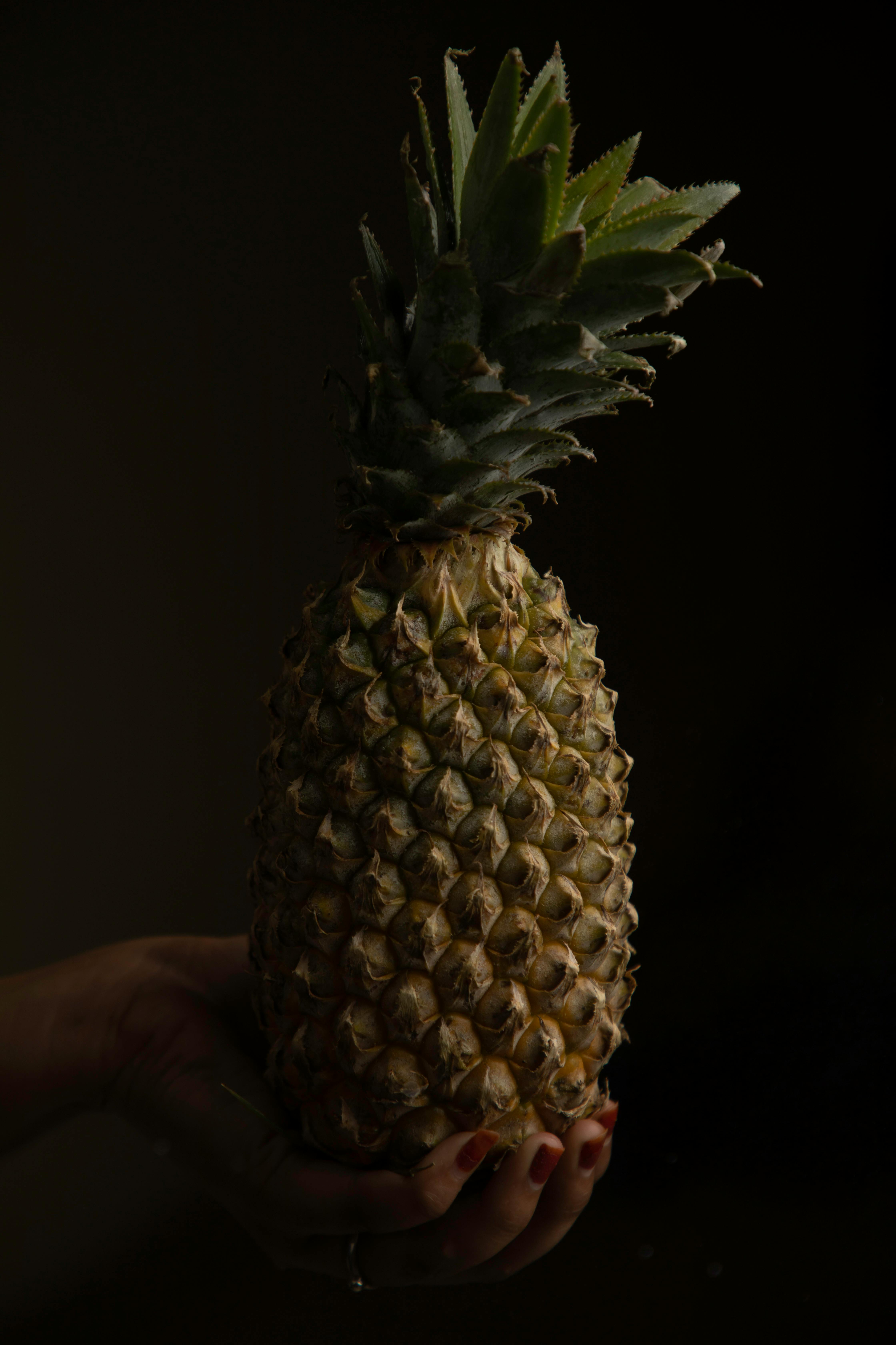 Exotic halved pineapple served on yellow table · Free Stock Photo
