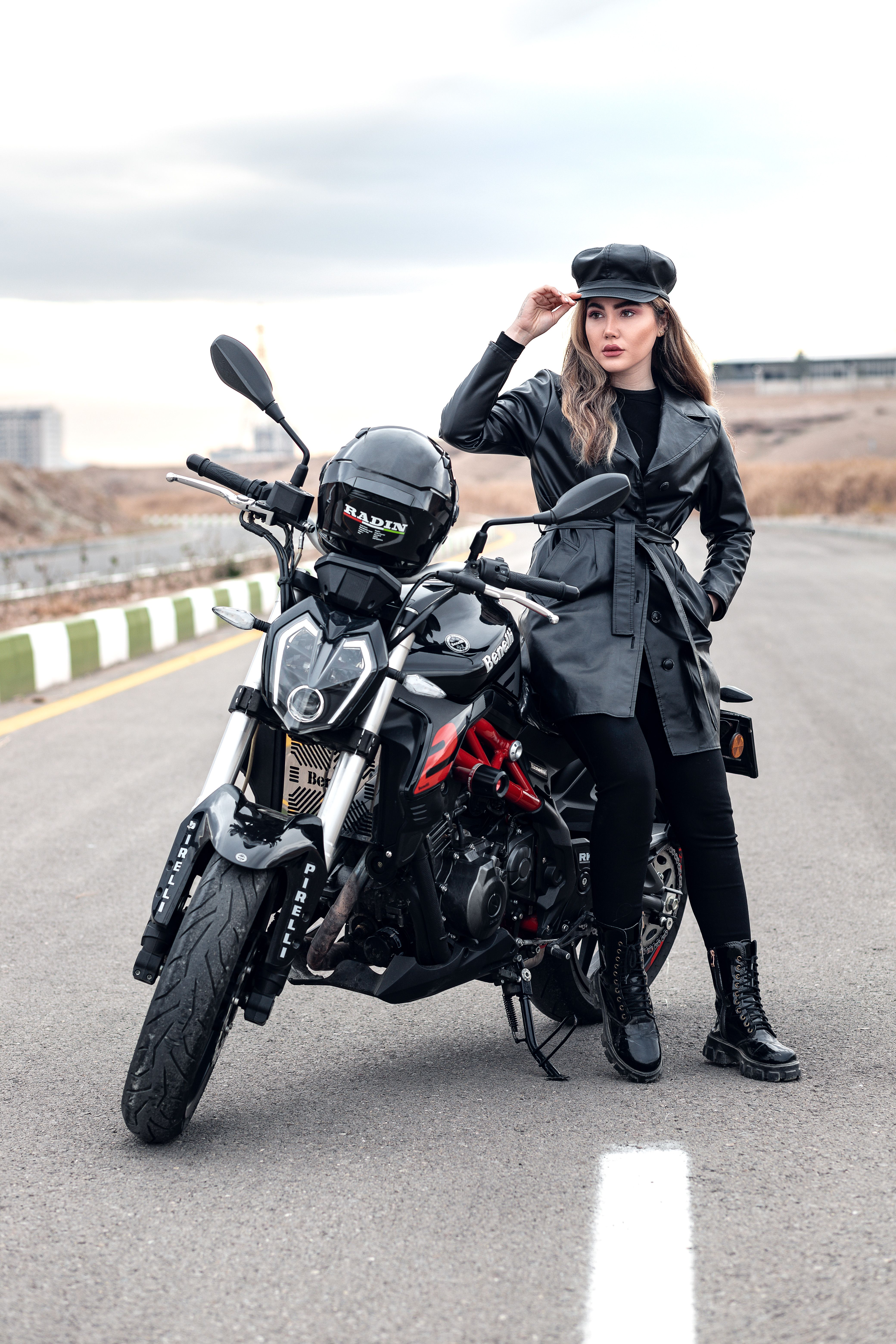 Stylish Woman Modeling near the Black Motorcycle · Free Stock Photo