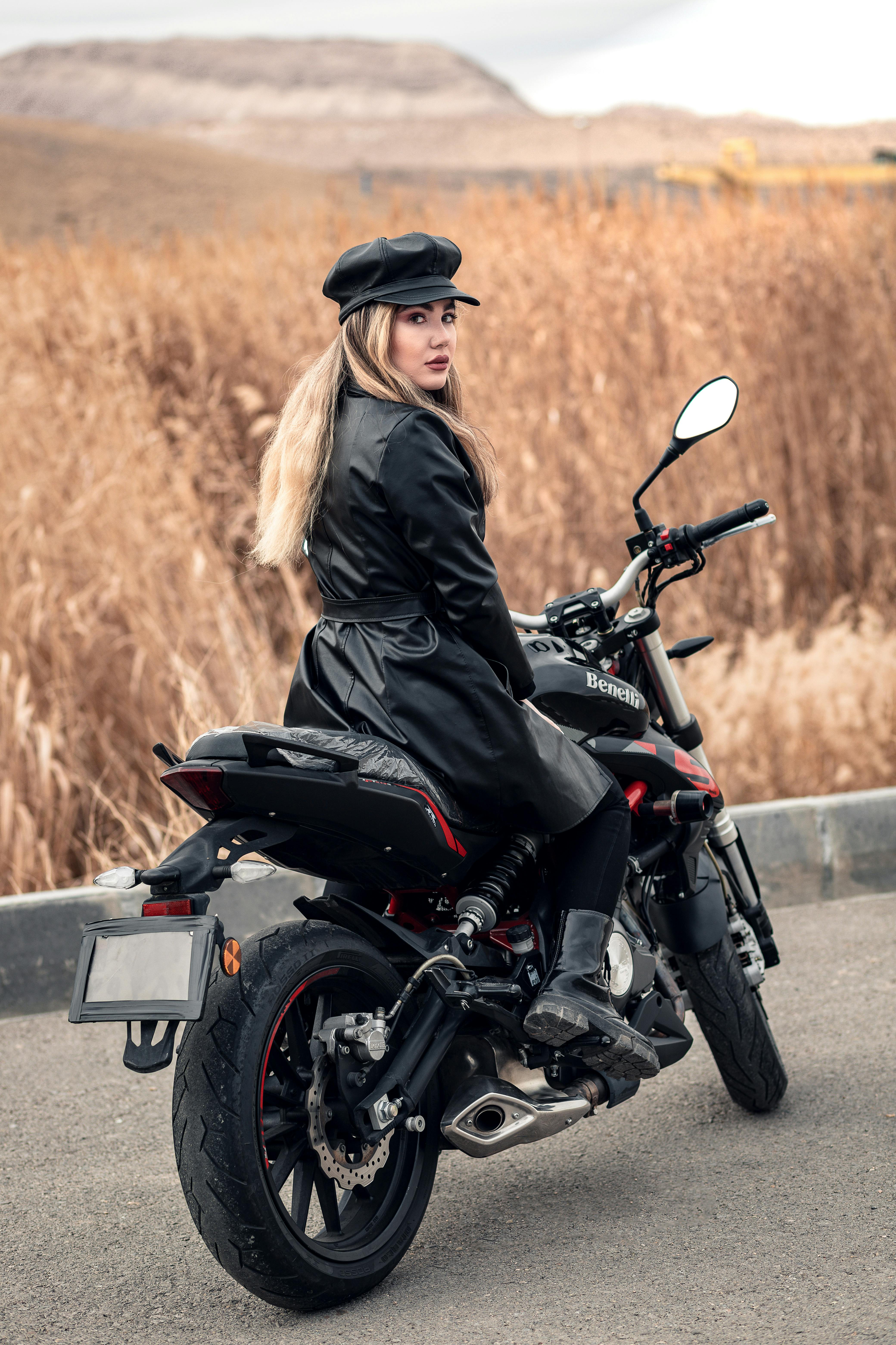 Woman Sitting on a Motorcycle Looking Back · Free Stock Photo