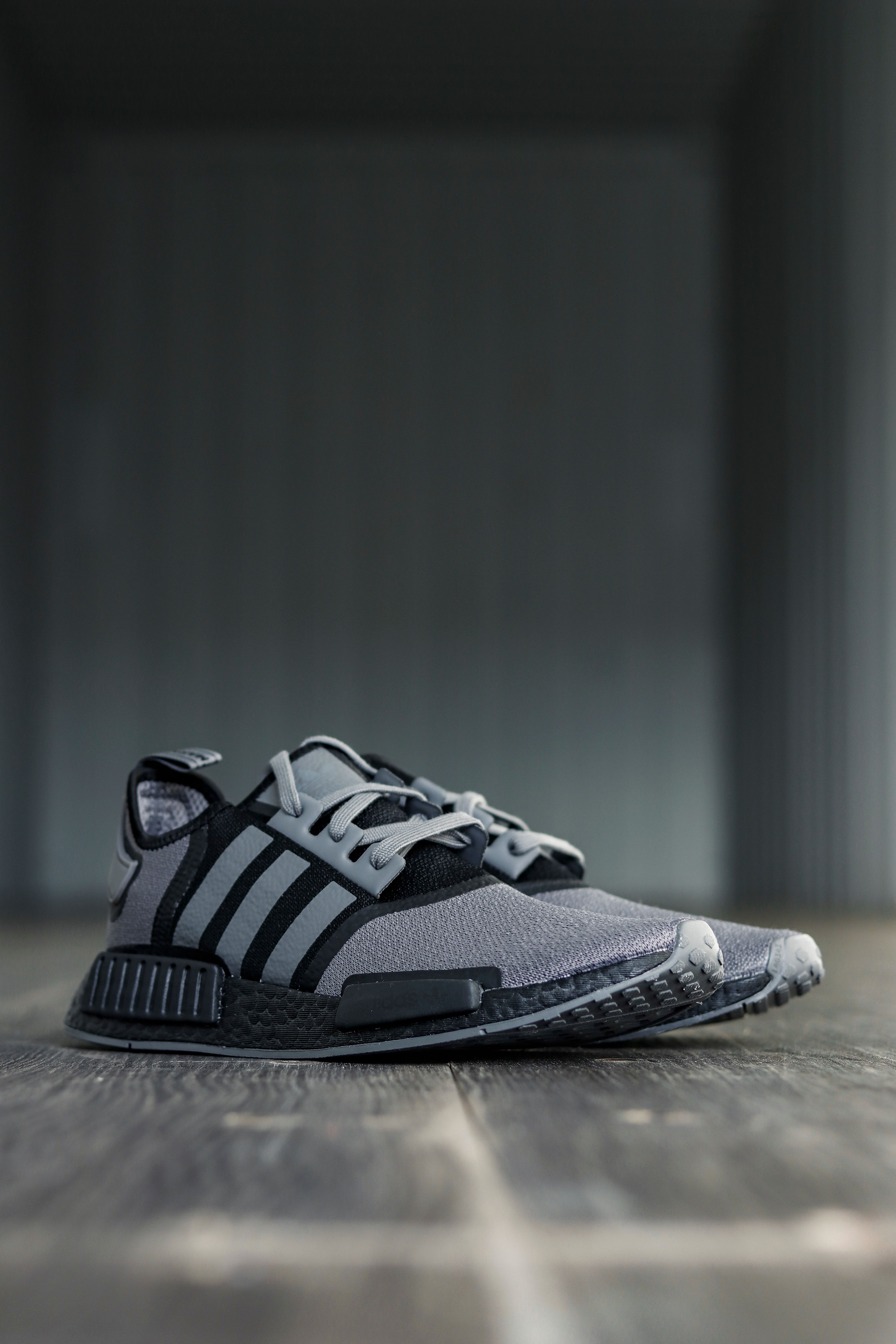 Close-Up Shot of Grey Rubber Shoes on Wooden Surface · Free Stock Photo