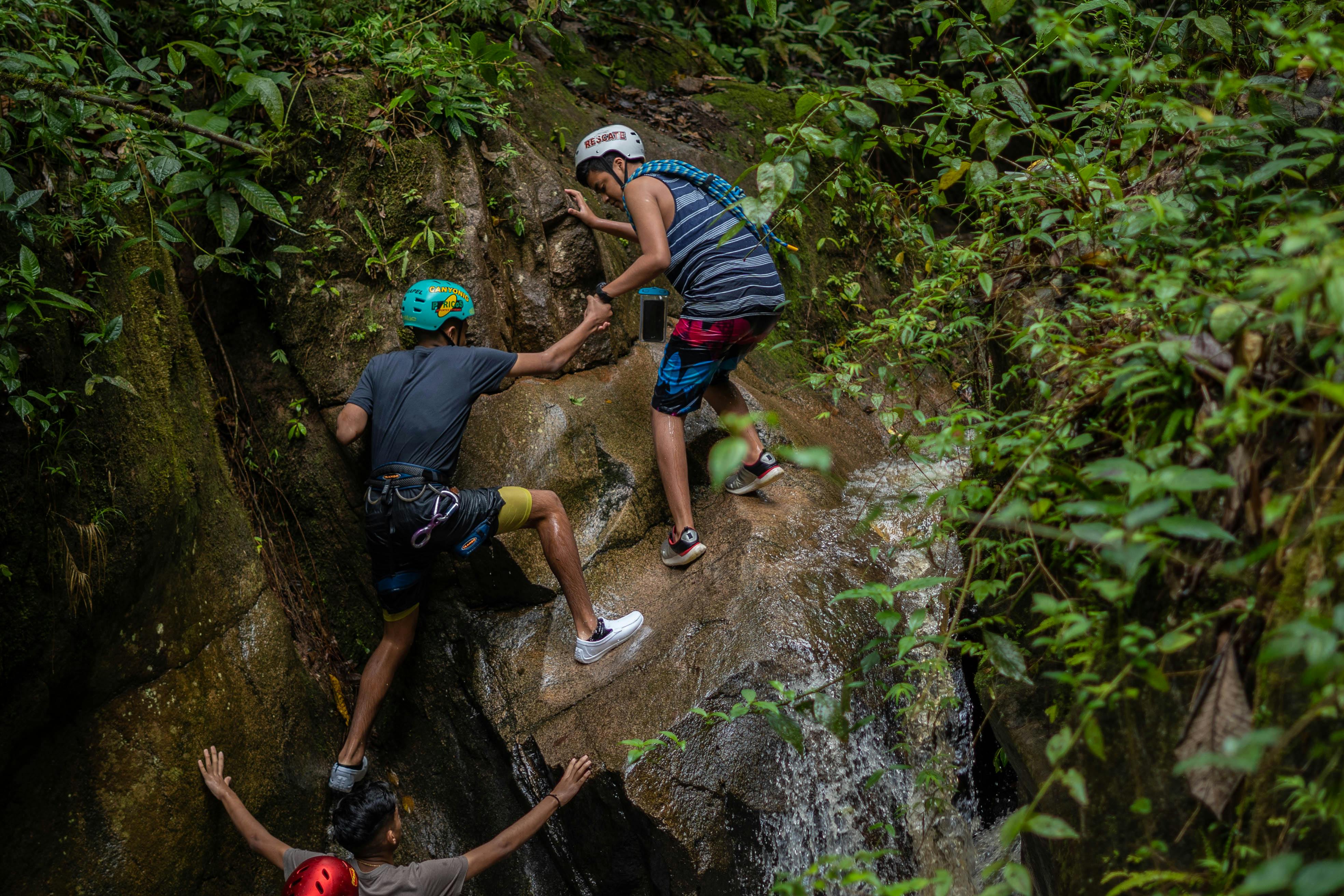 Three People Climbing on the Big Rocks · Free Stock Photo