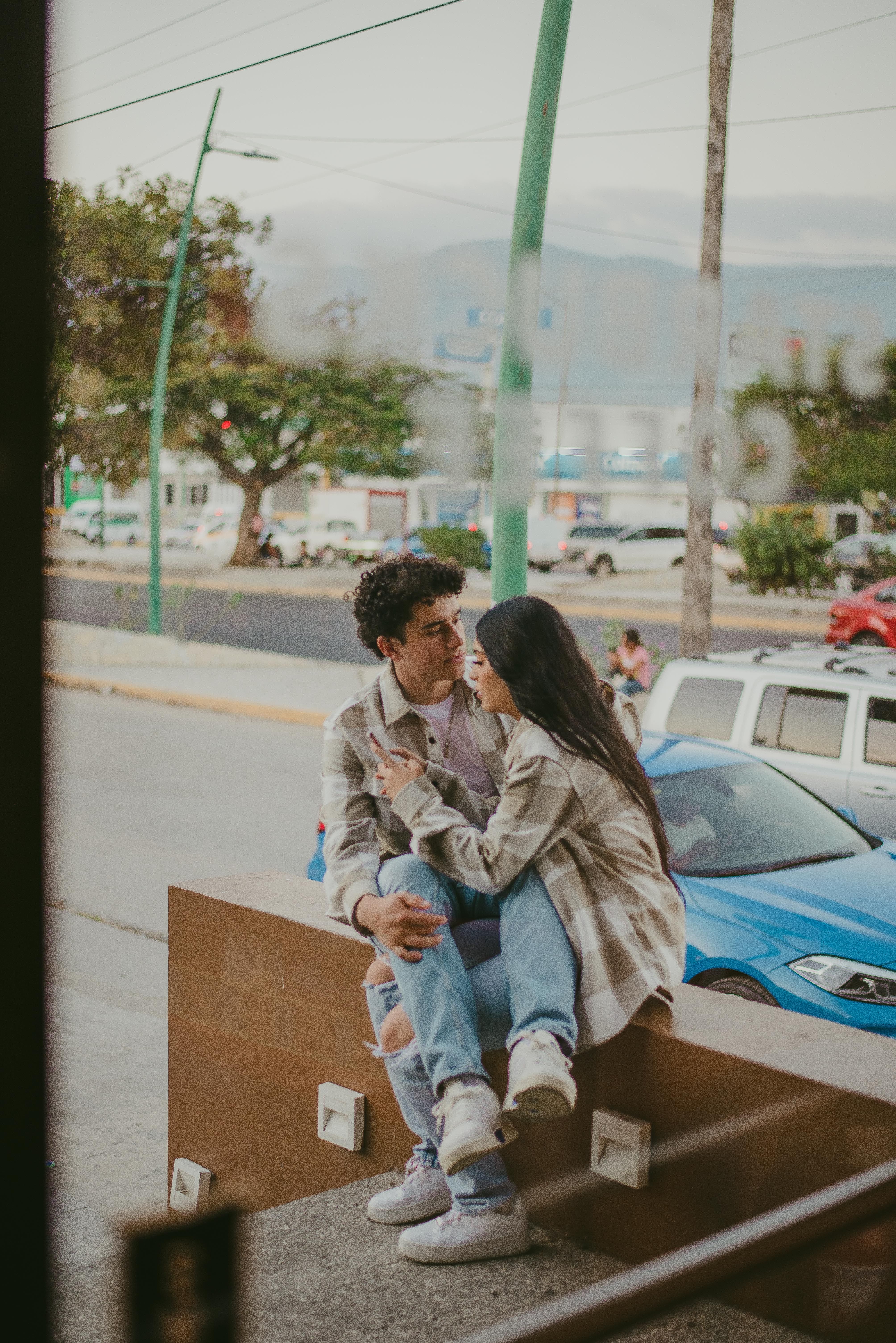 Couple Hugging on Wall by Car · Free Stock Photo