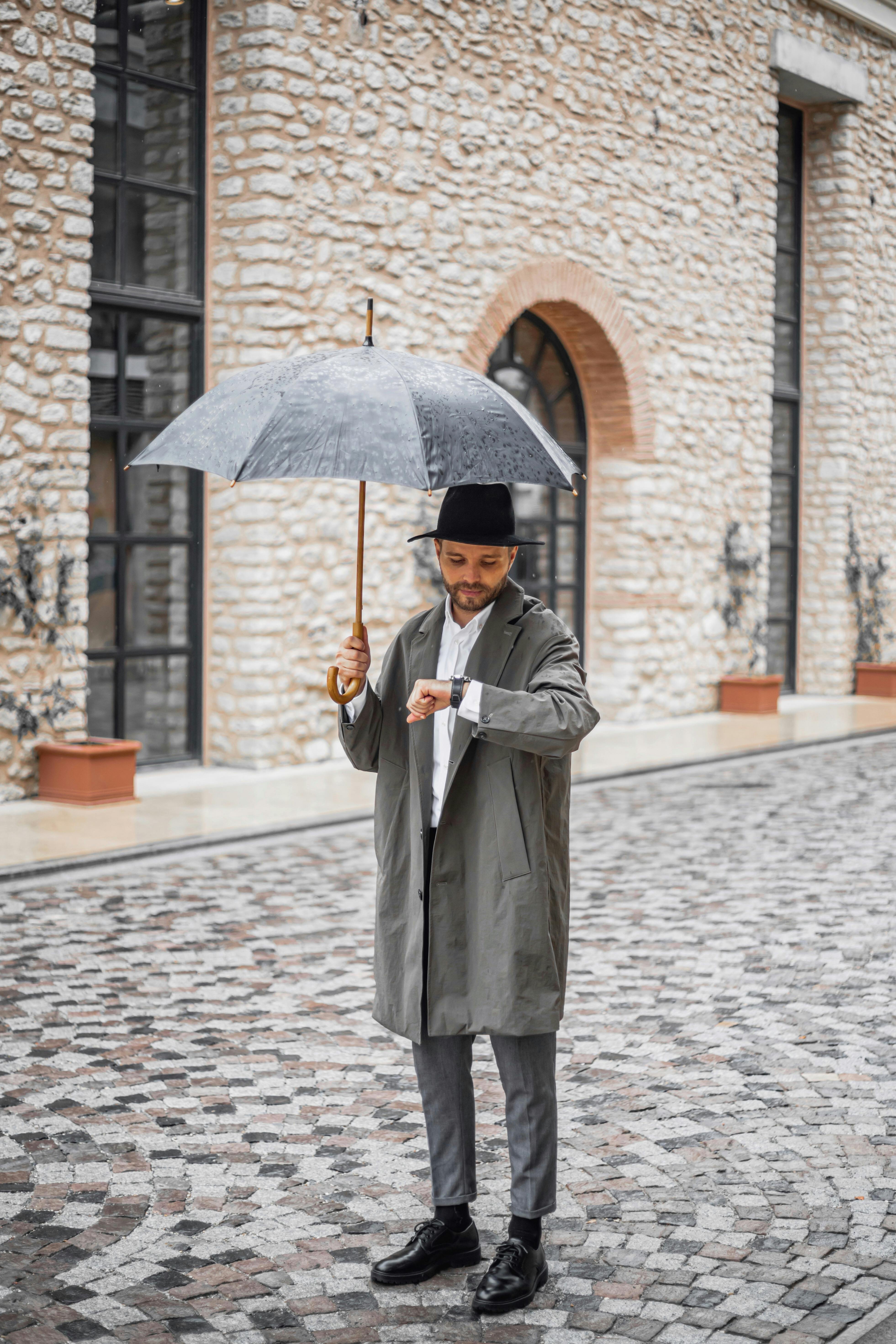 Man with Umbrella near Building · Free Stock Photo