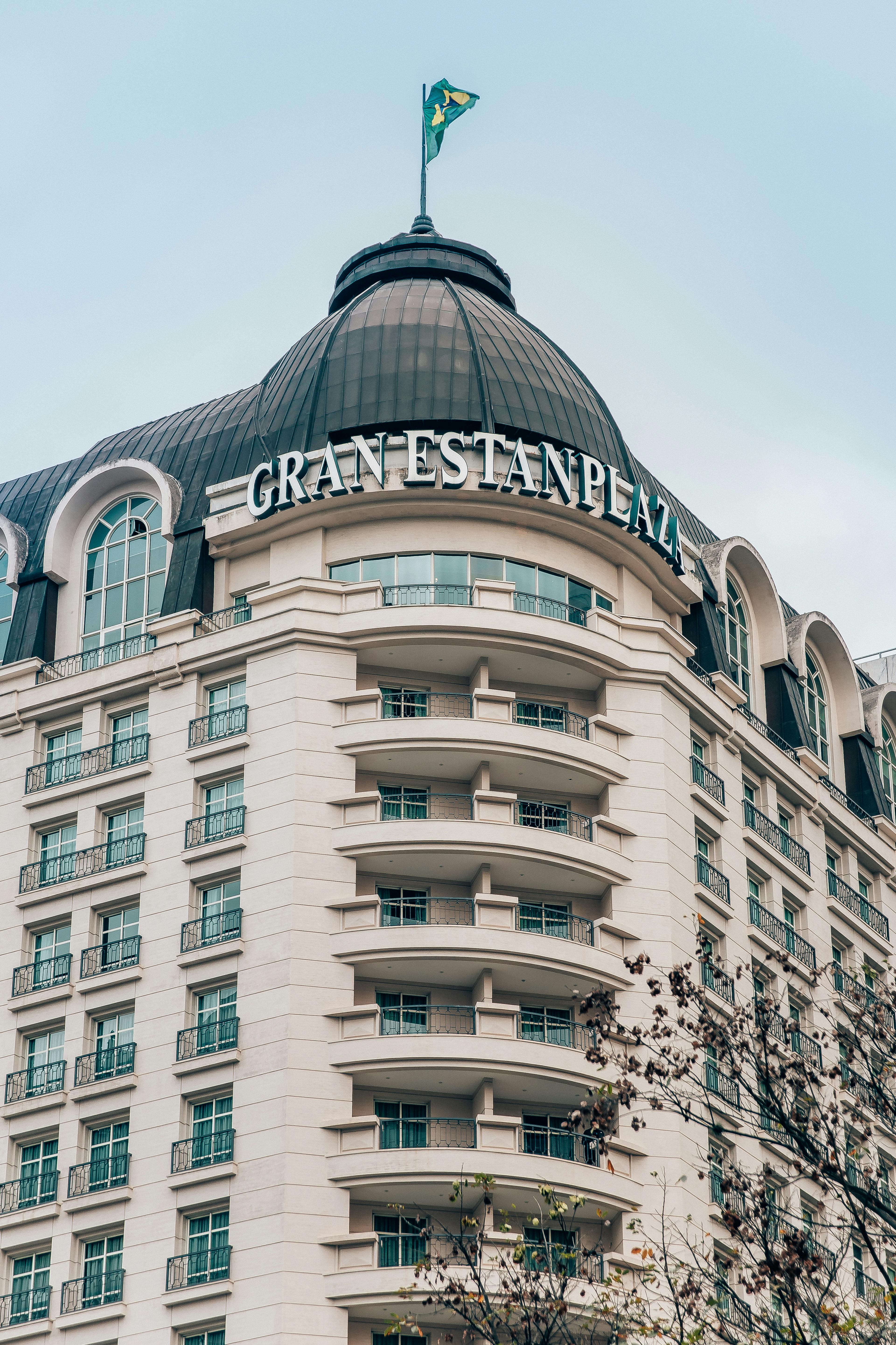 Low-angle Photography of Beige Concrete Building · Free Stock Photo