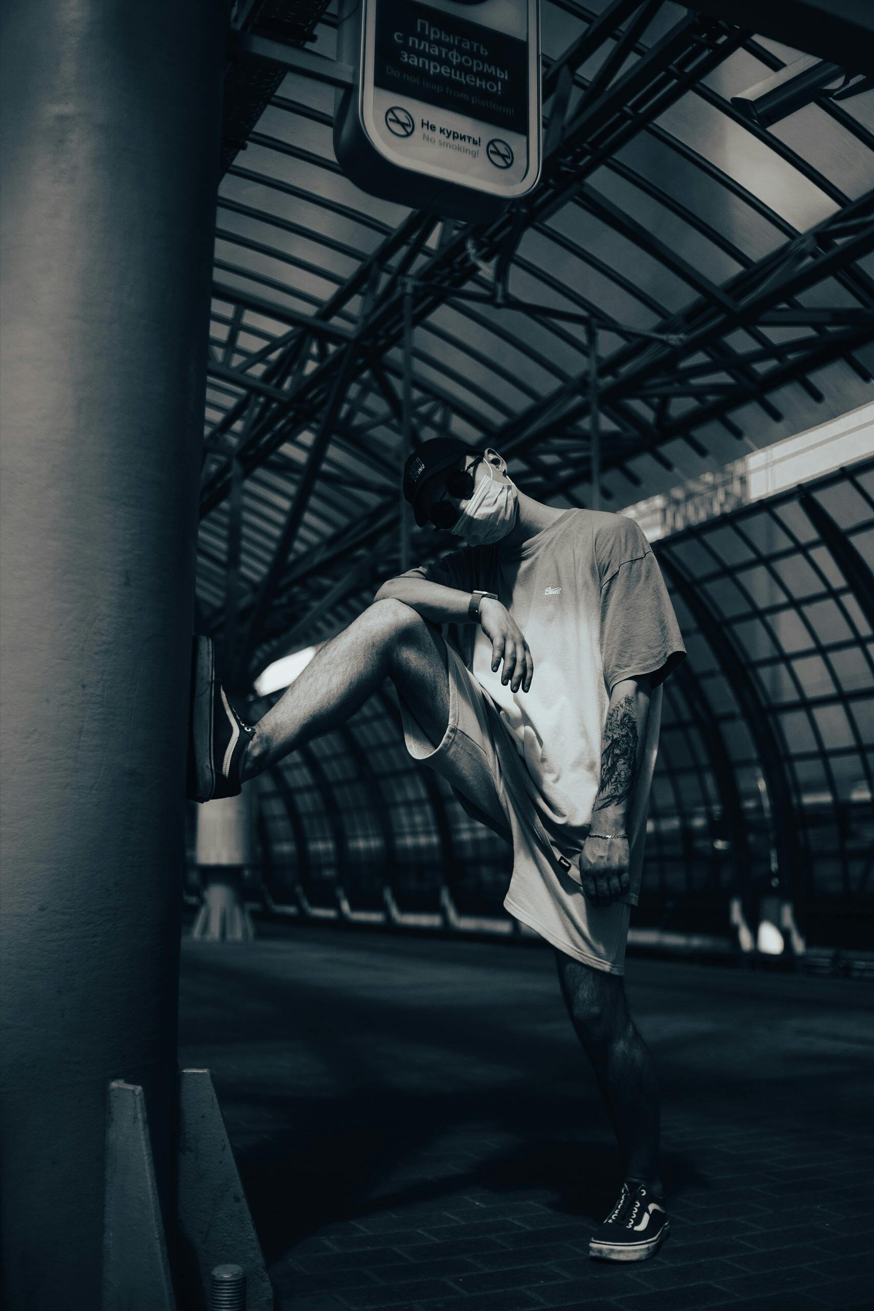 Man Standing with Leg Up on a Column · Free Stock Photo