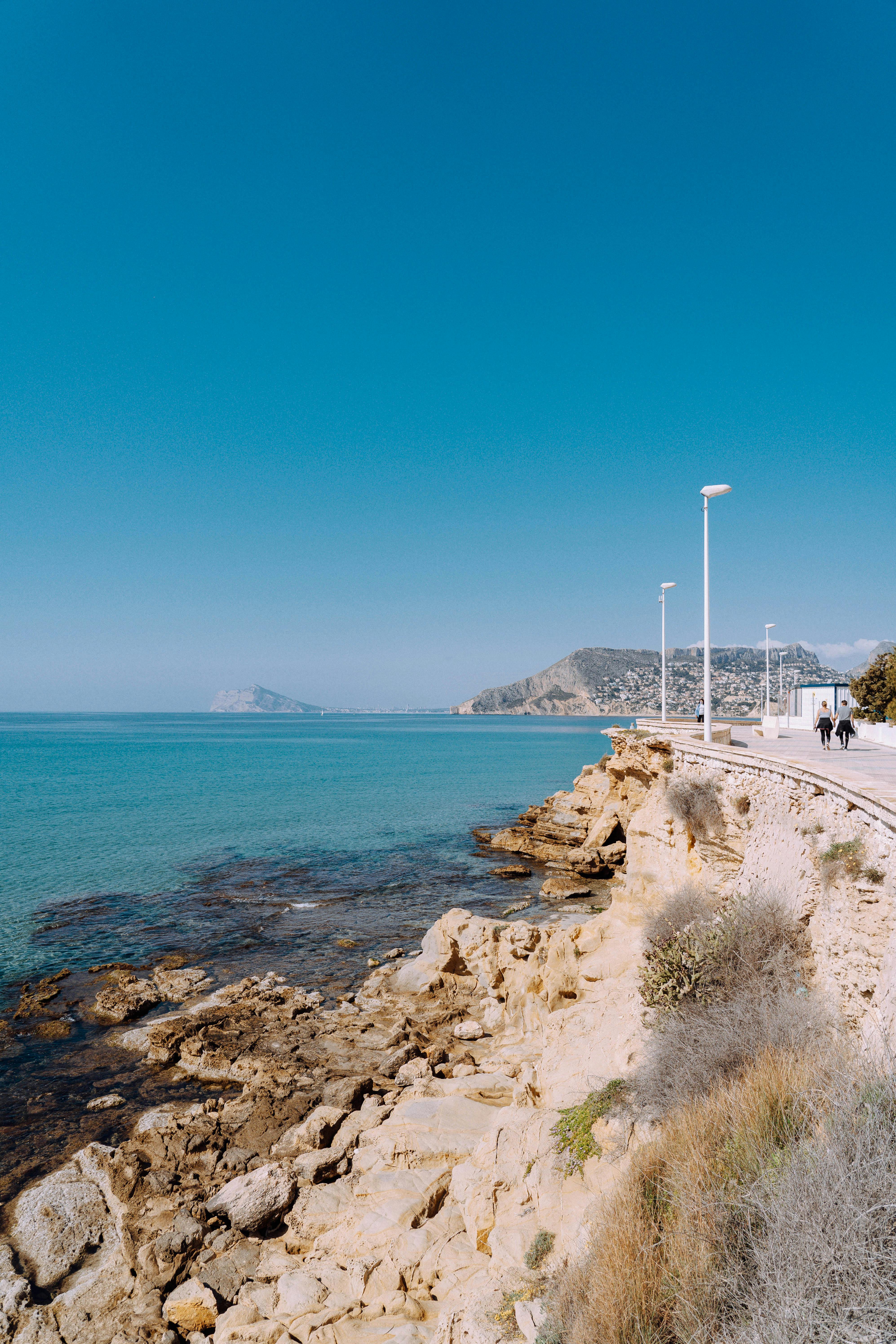 Rocky Shore Under Blue Sky · Free Stock Photo