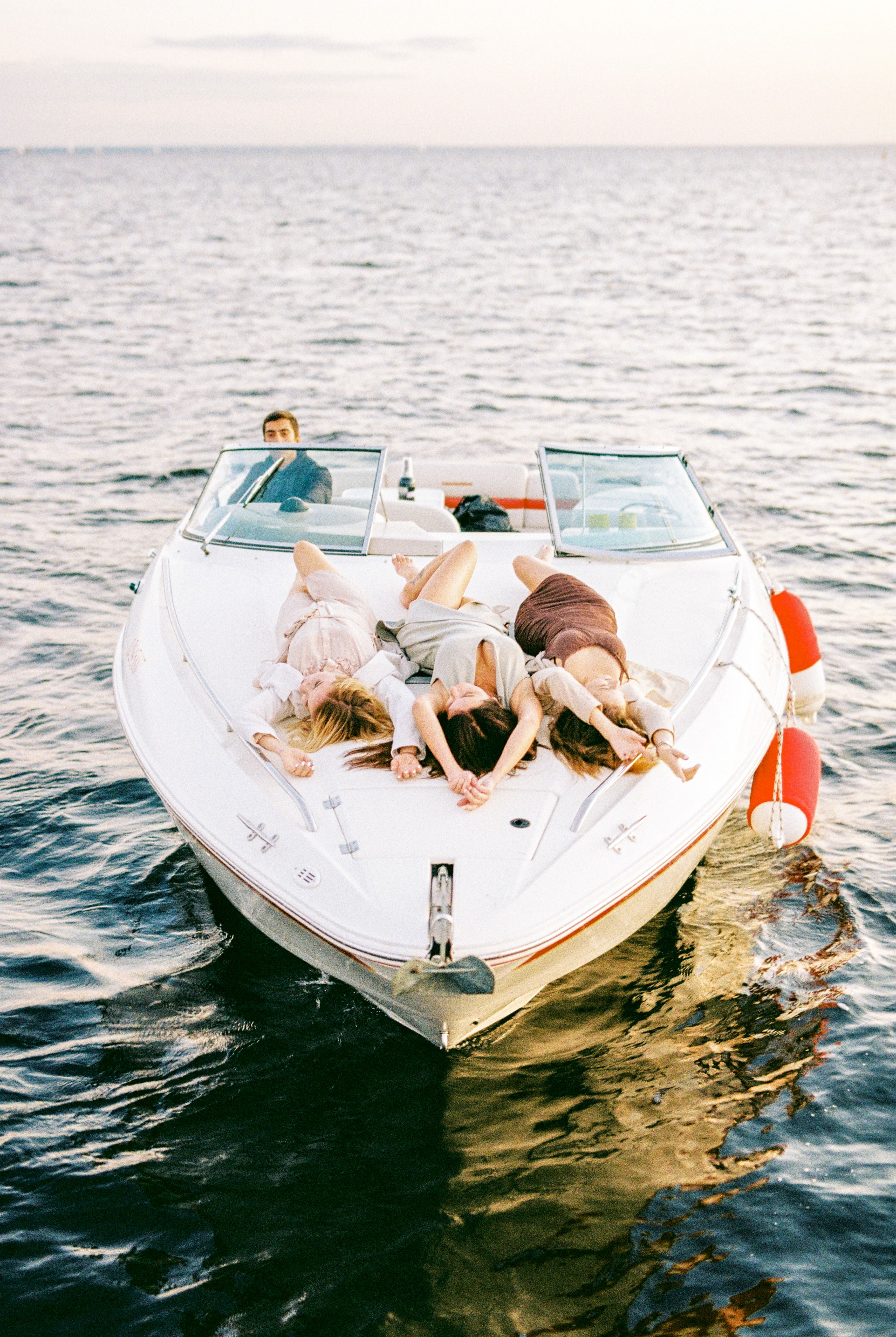 Women Lying on White Boat · Free Stock Photo