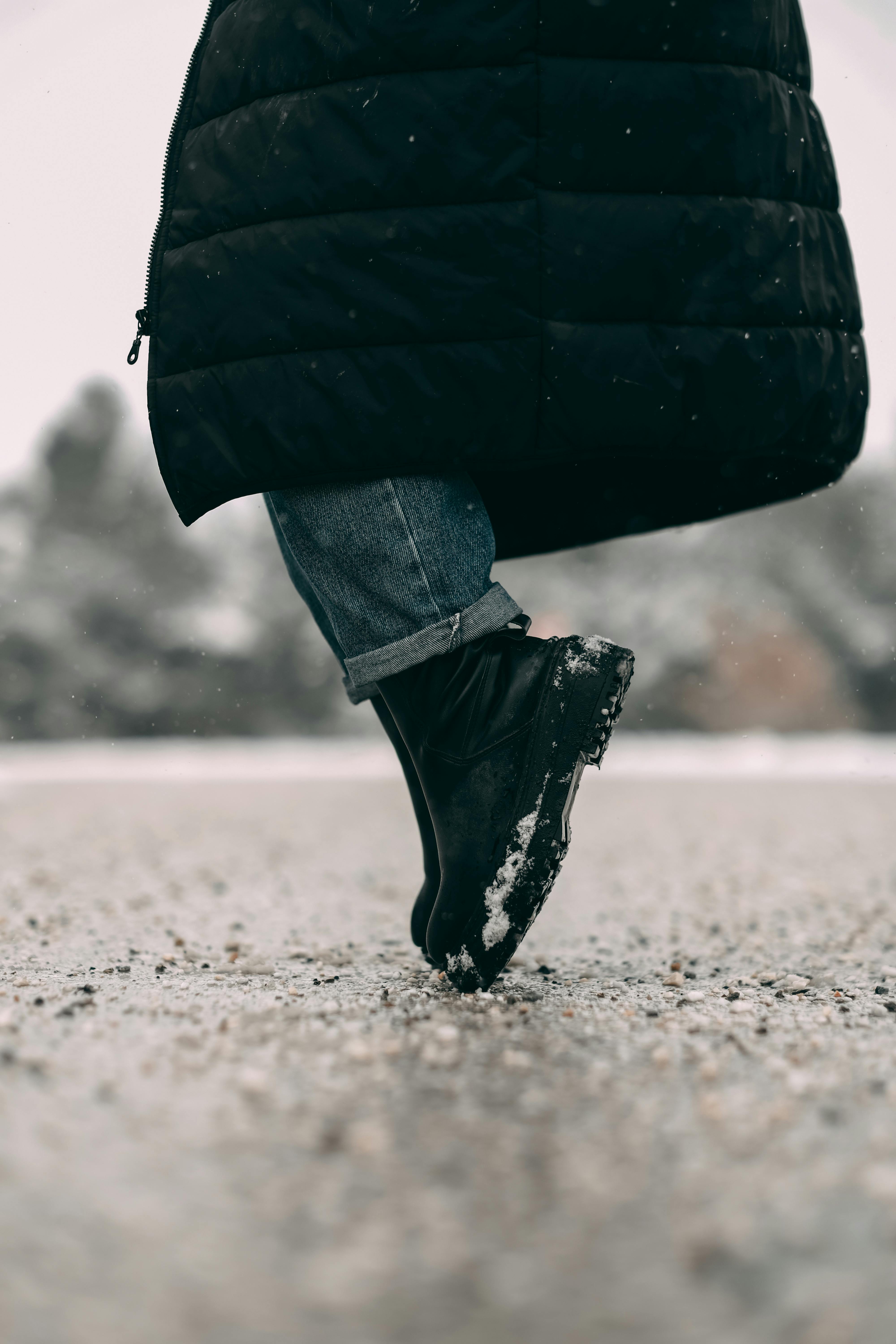 Snow on a Person's Boots Tiptoeing on Pavement · Free Stock Photo