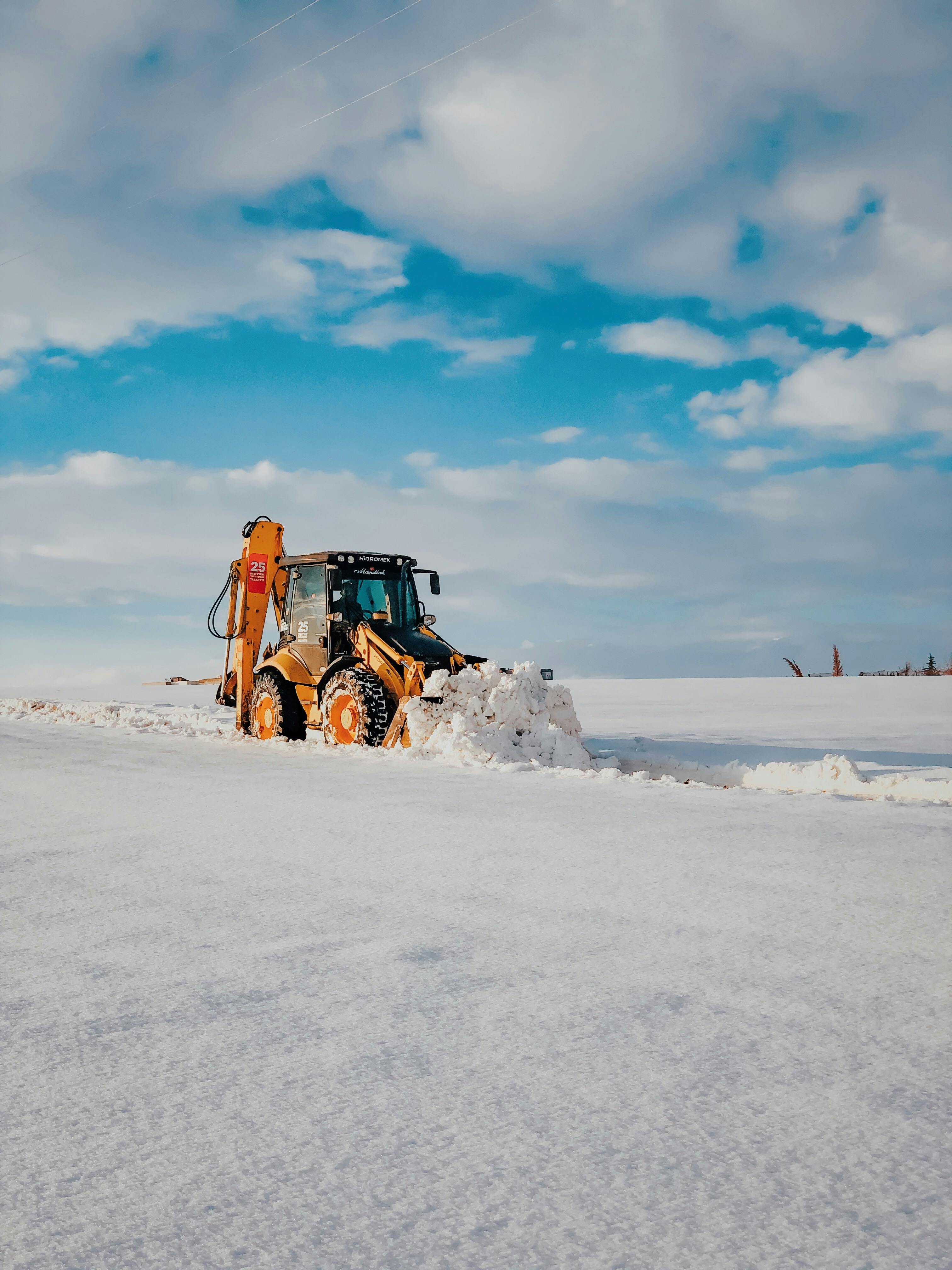 Yellow and Black Heavy Equipment on Snow Covered Ground · Free Stock Photo