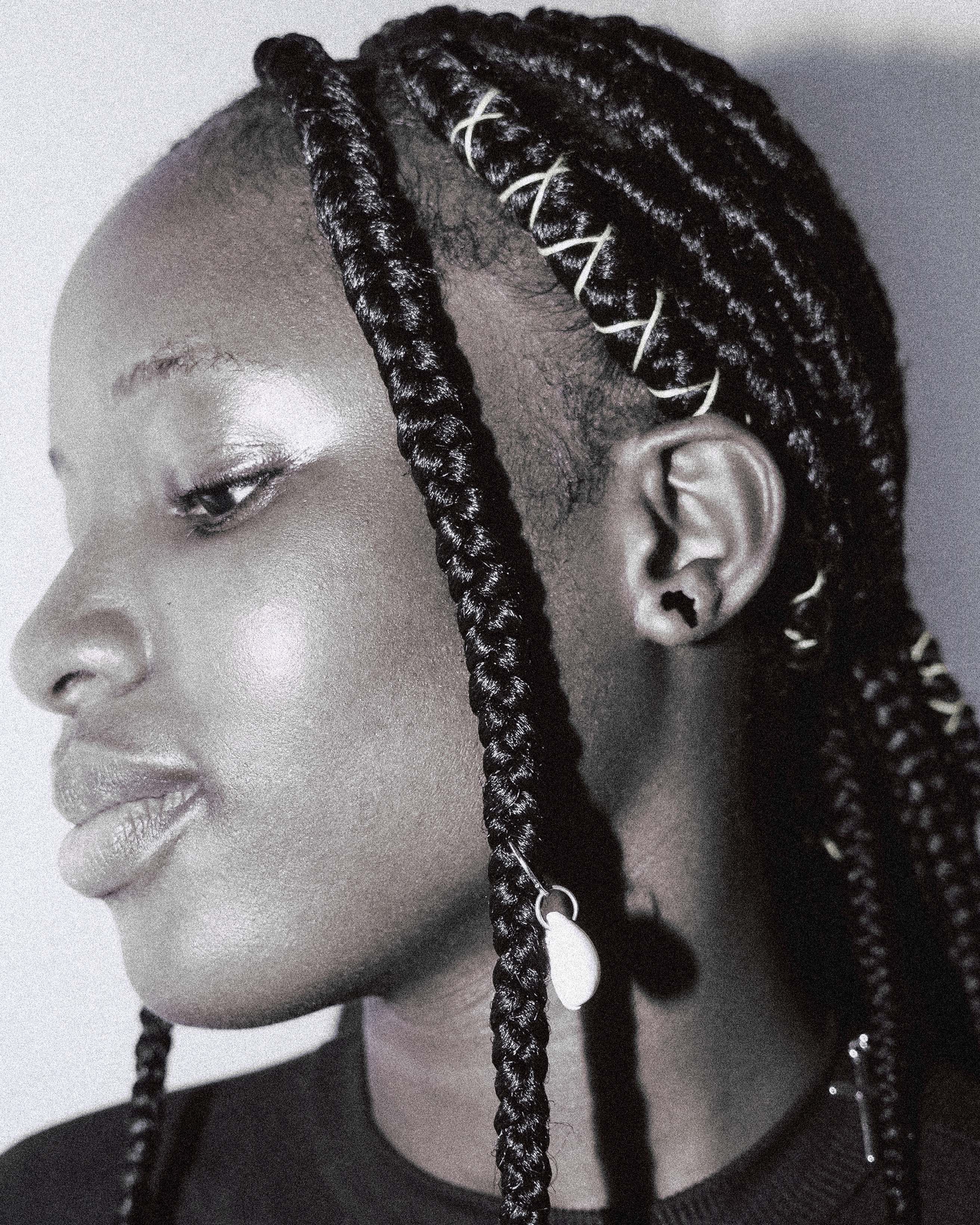 Side View of a Woman with Braided Hairstyle · Free Stock Photo
