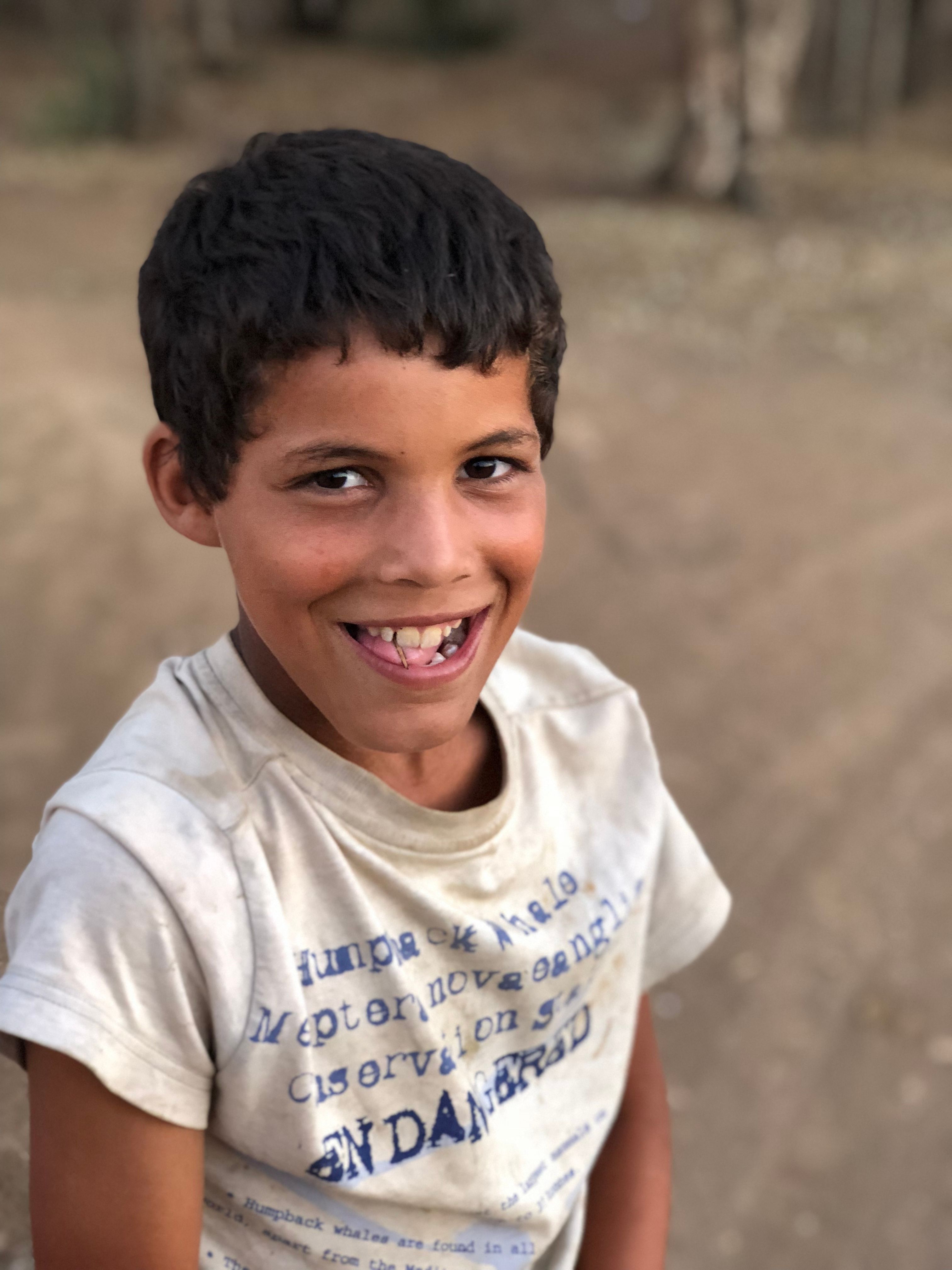 A Smiling Boy Wearing Dirty White Shirt · Free Stock Photo