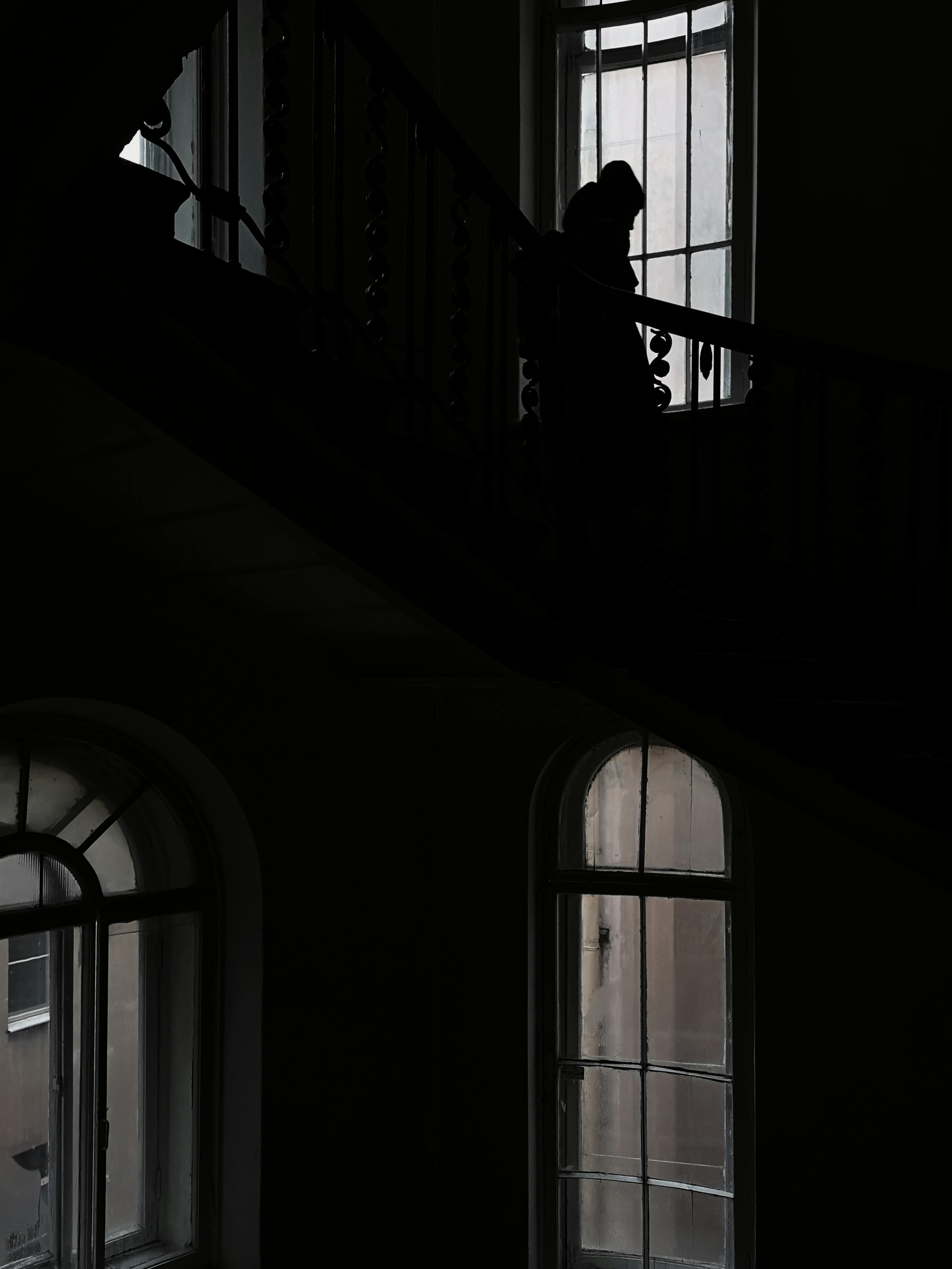 Person Standing Inside a Room with Wooden Tables and Chairs · Free ...
