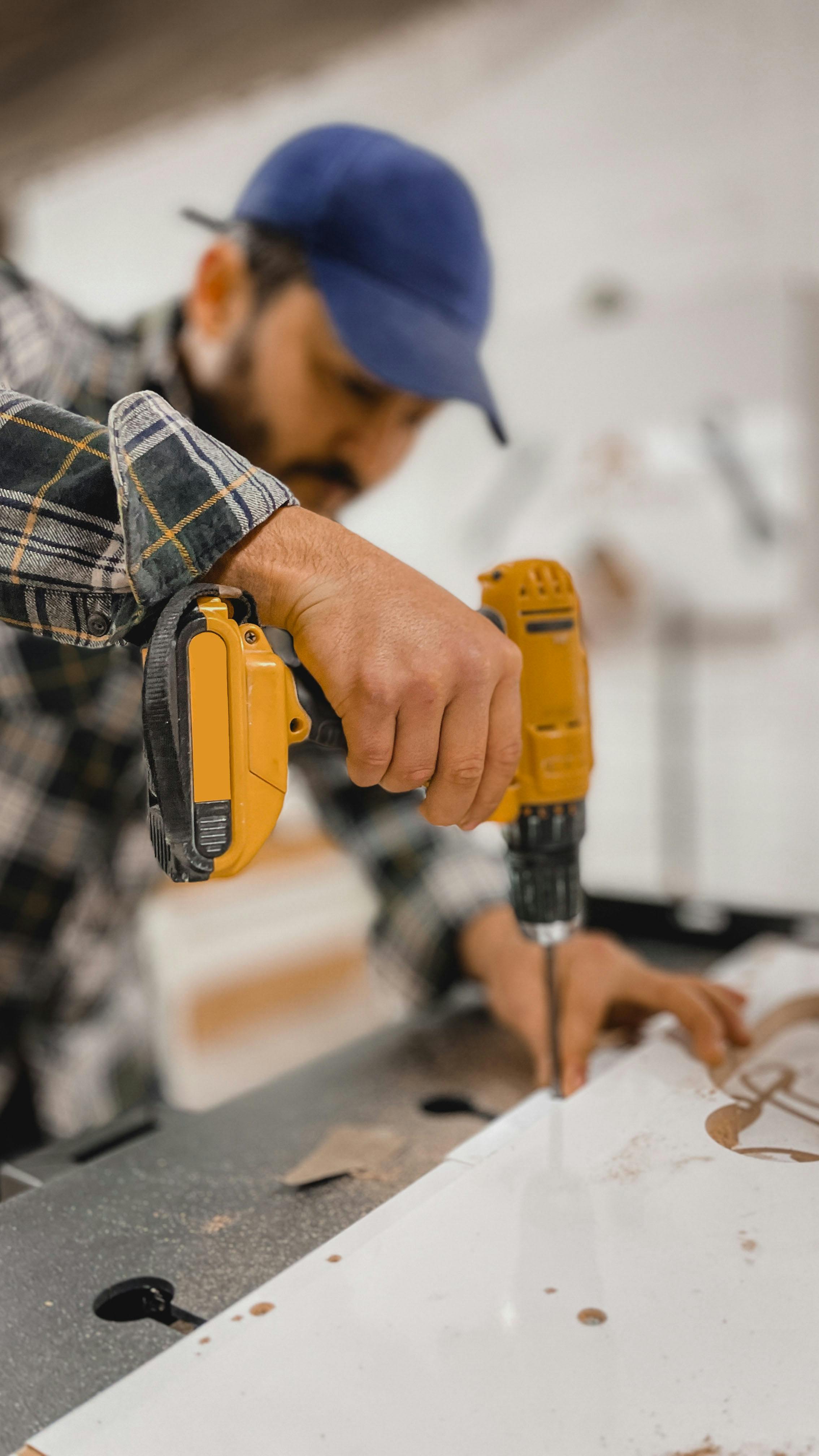 A Person Drilling a Wood · Free Stock Photo