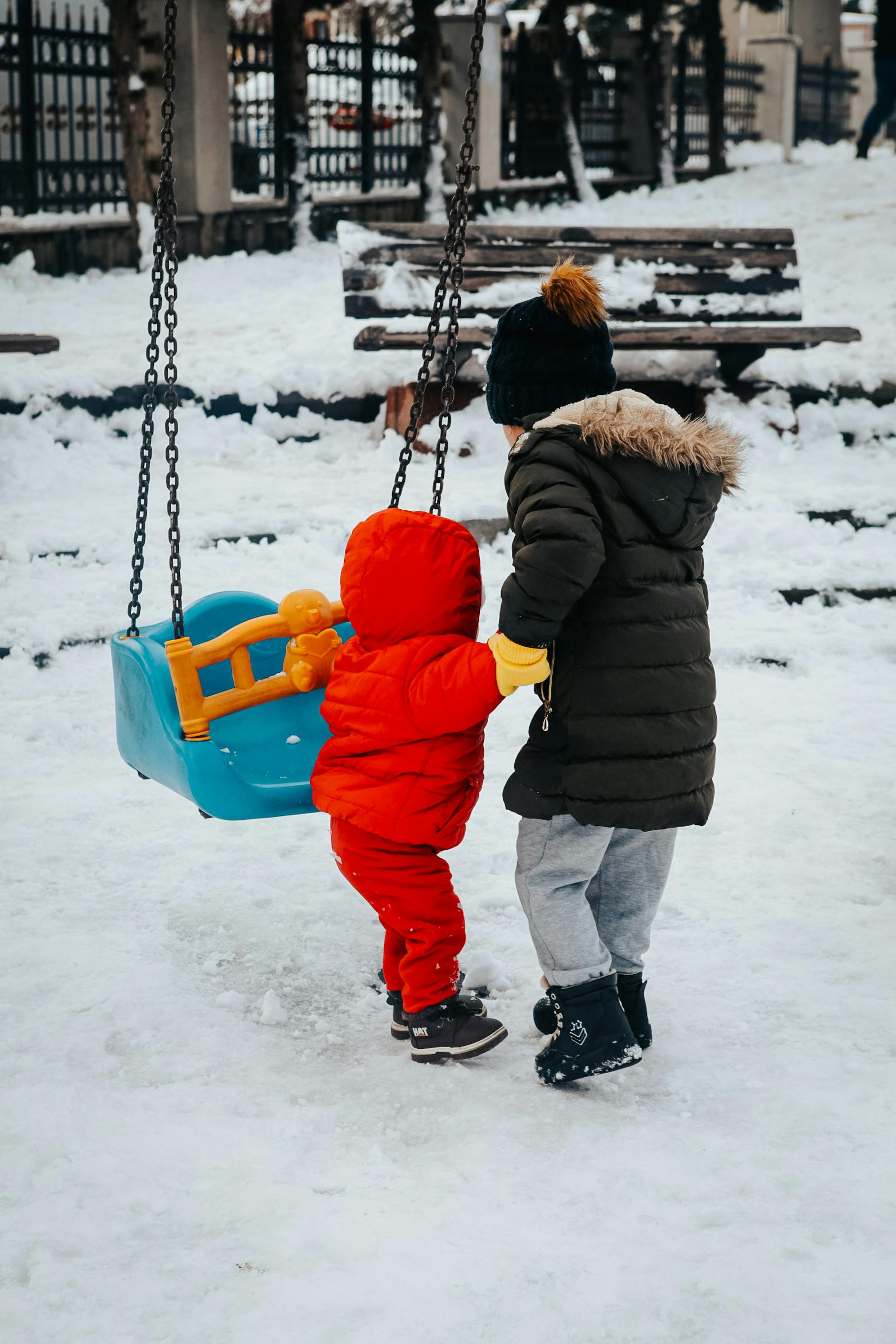 Kids Playing in the Snow Covered Playground · Free Stock Photo