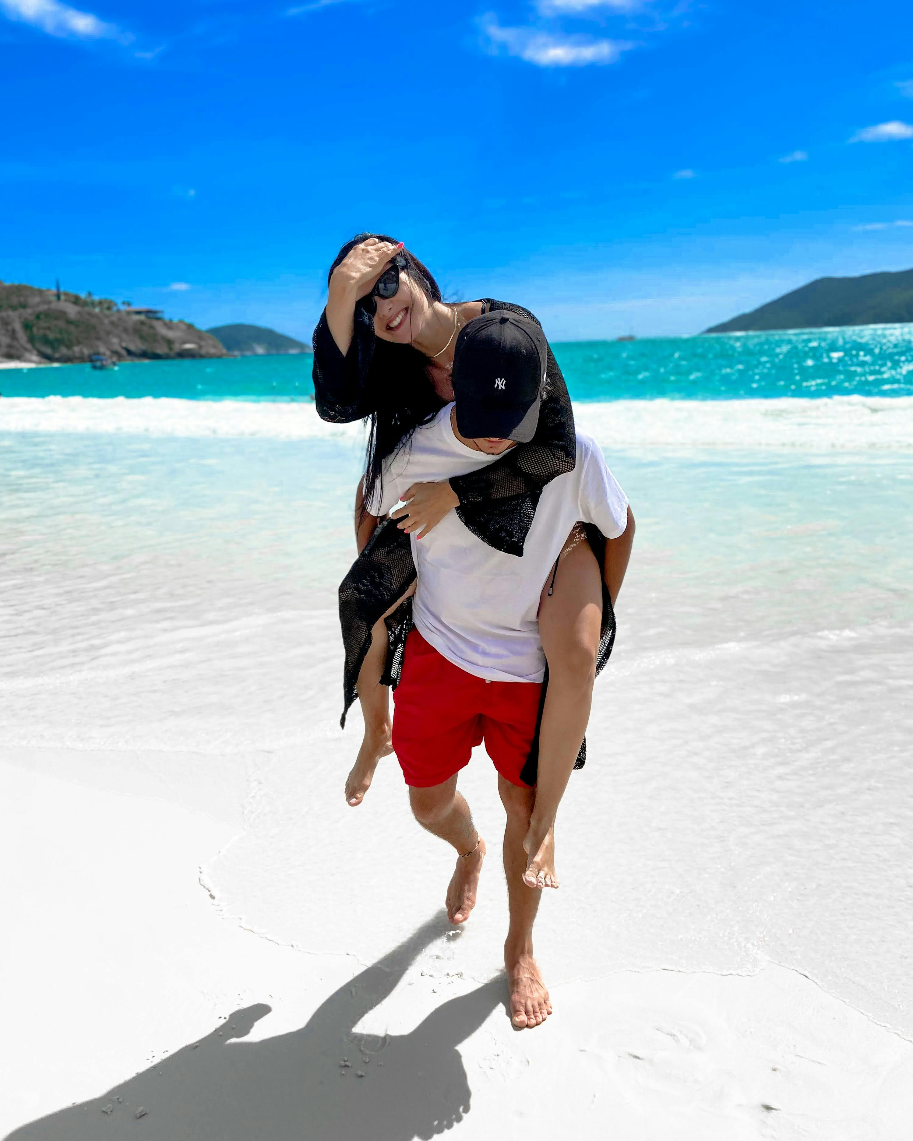 Man and Woman Piggy Back Riding in Field · Free Stock Photo
