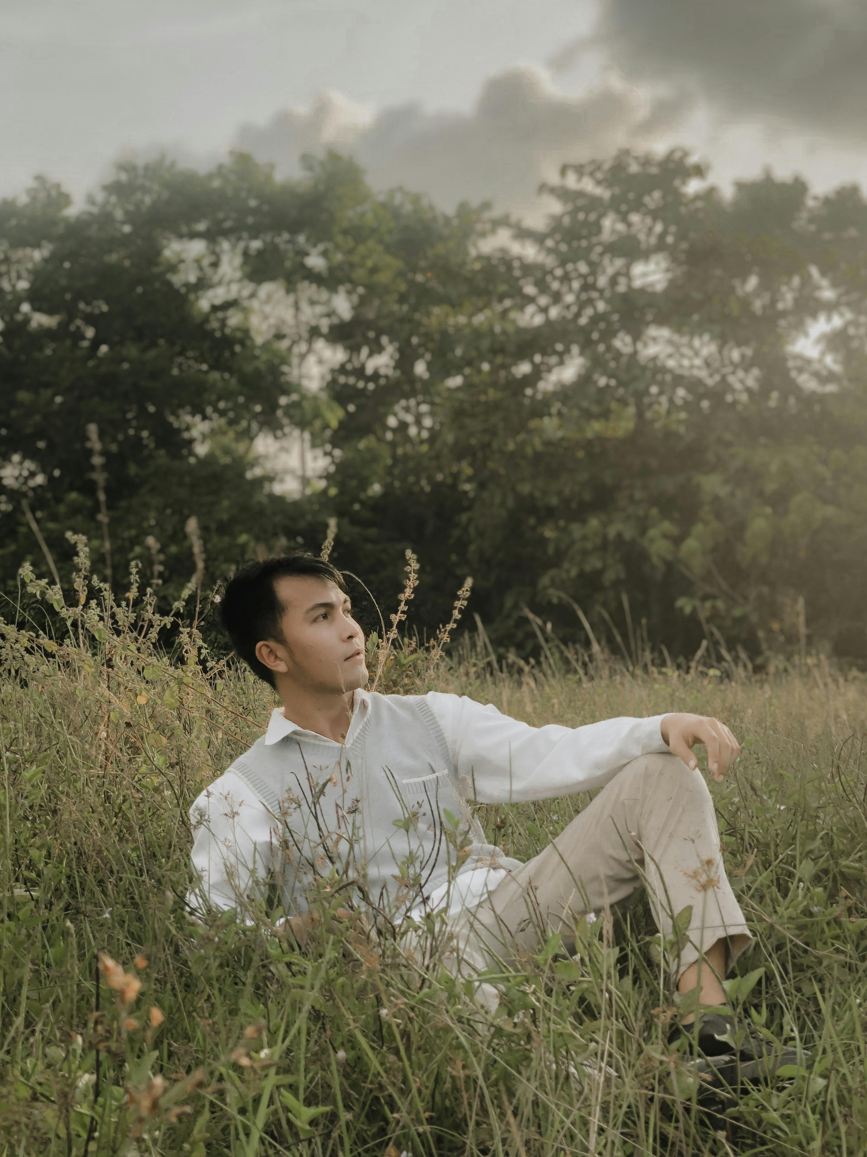 A Man in Formal Wear Sitting on Grass · Free Stock Photo