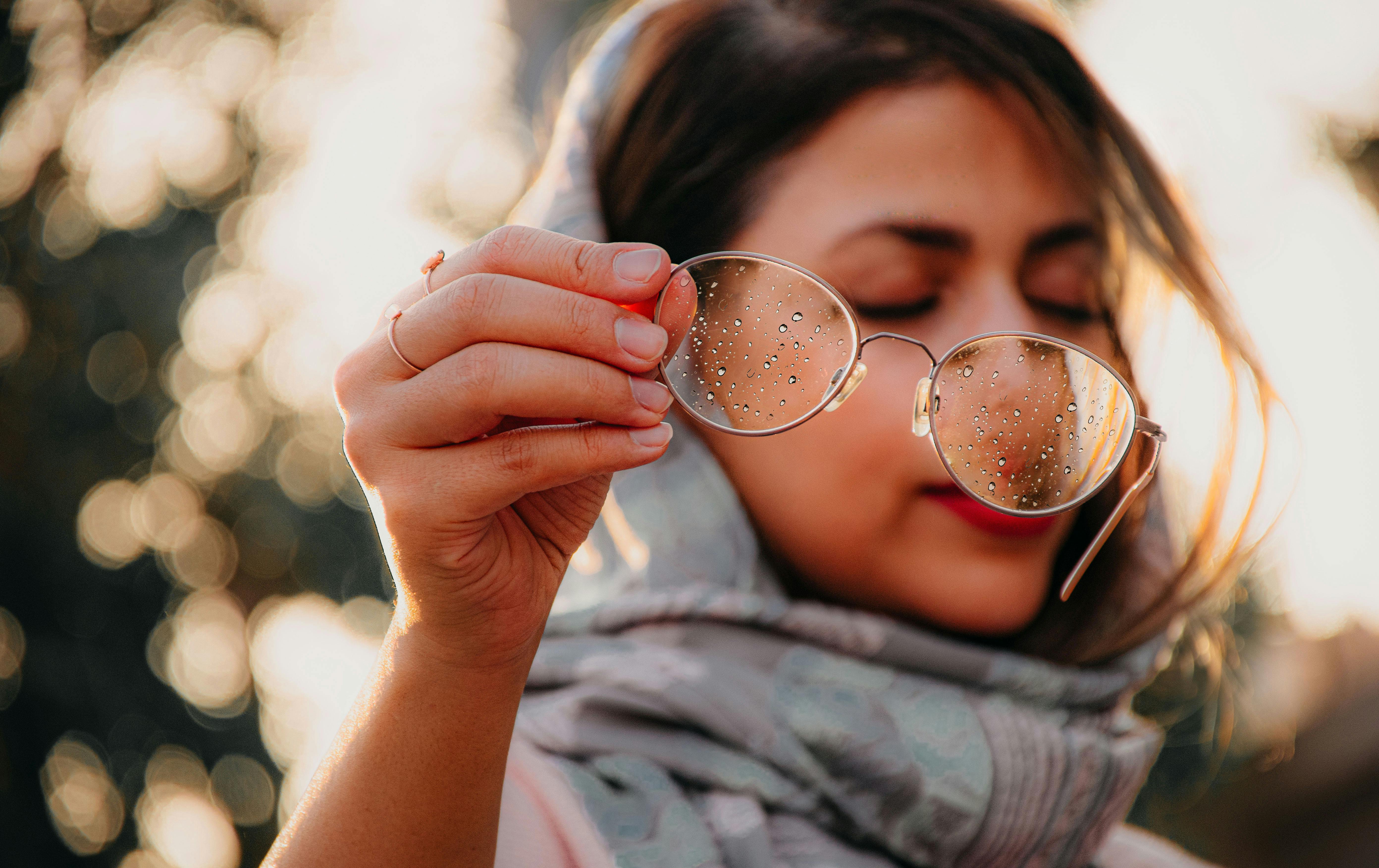 Close Up Photo of Woman Holding Eyeglasses · Free Stock Photo