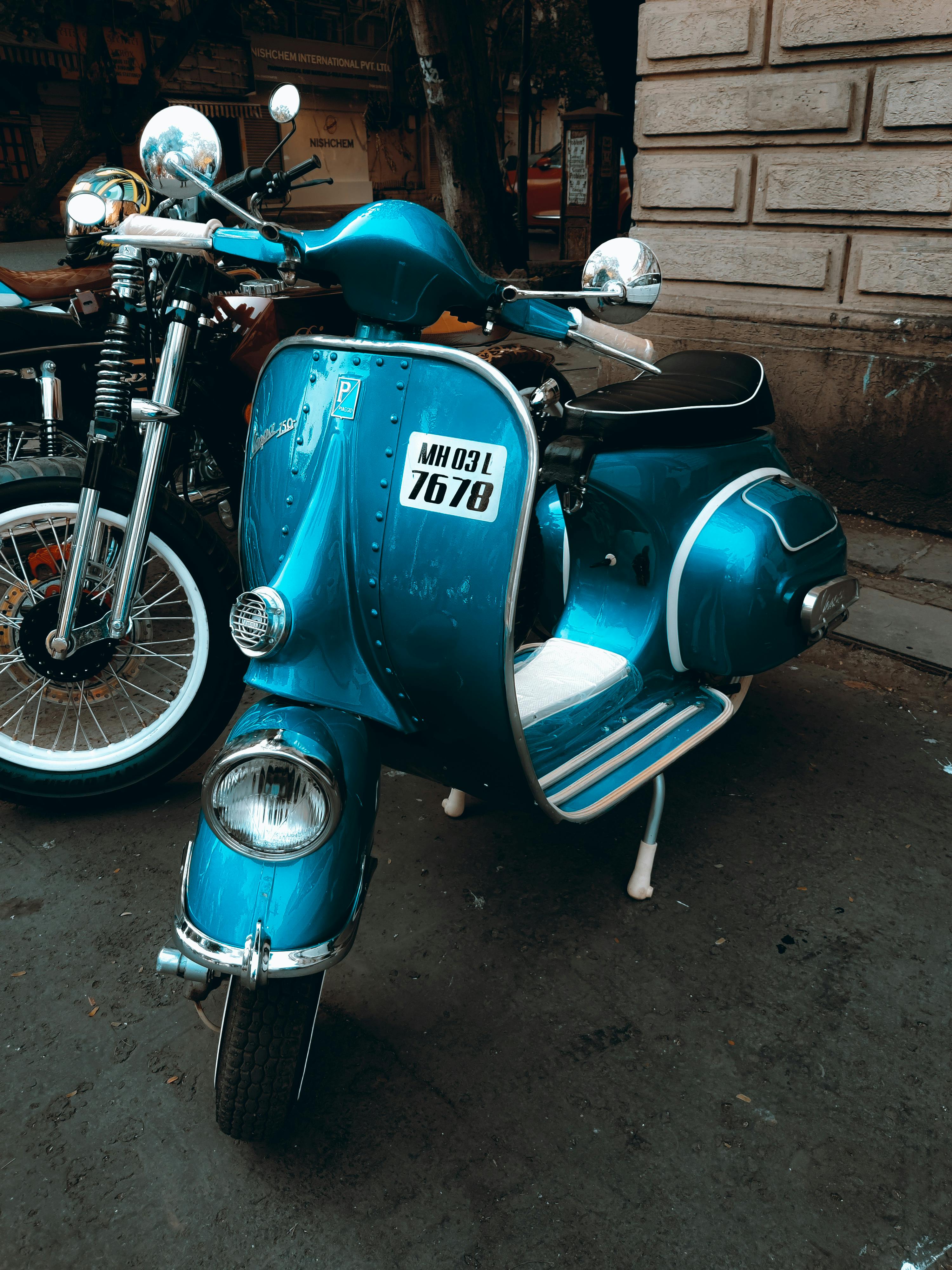 Blue Scooter Parked Beside a Wall · Free Stock Photo
