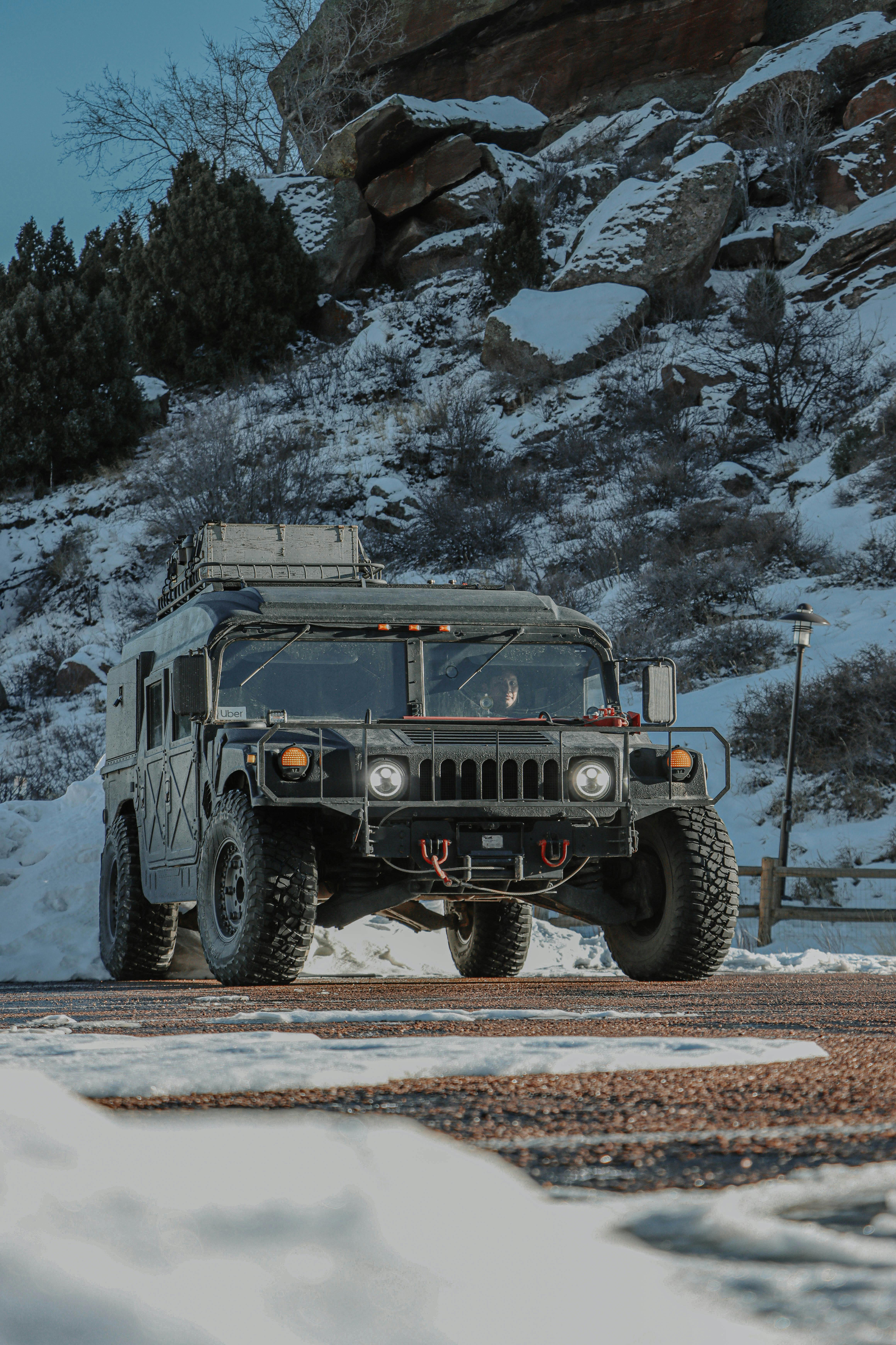 Humvee Driving on Snow Covered Road · Free Stock Photo