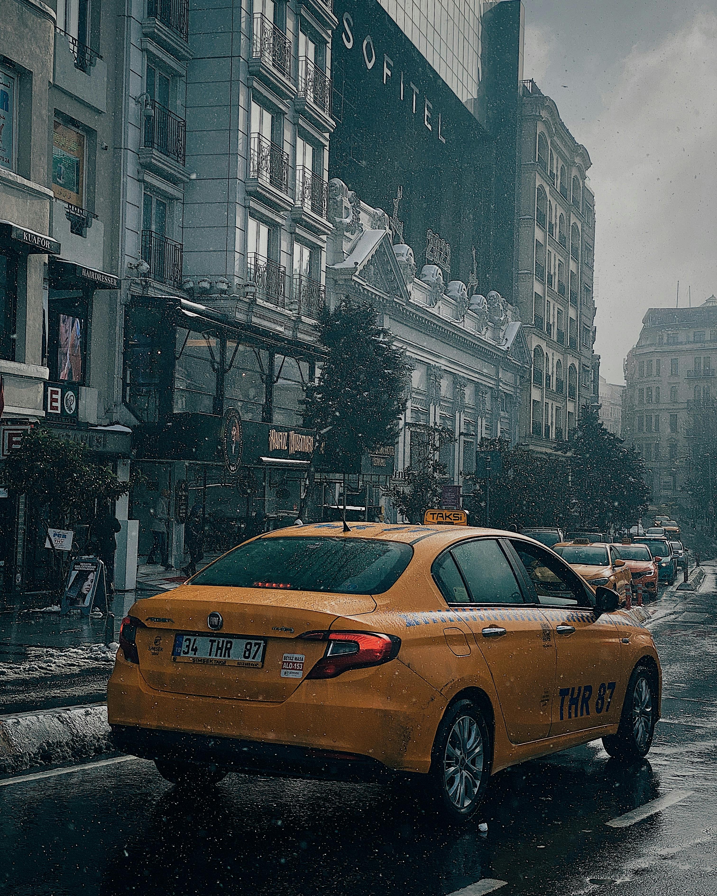 Taxi Driving on City Street · Free Stock Photo