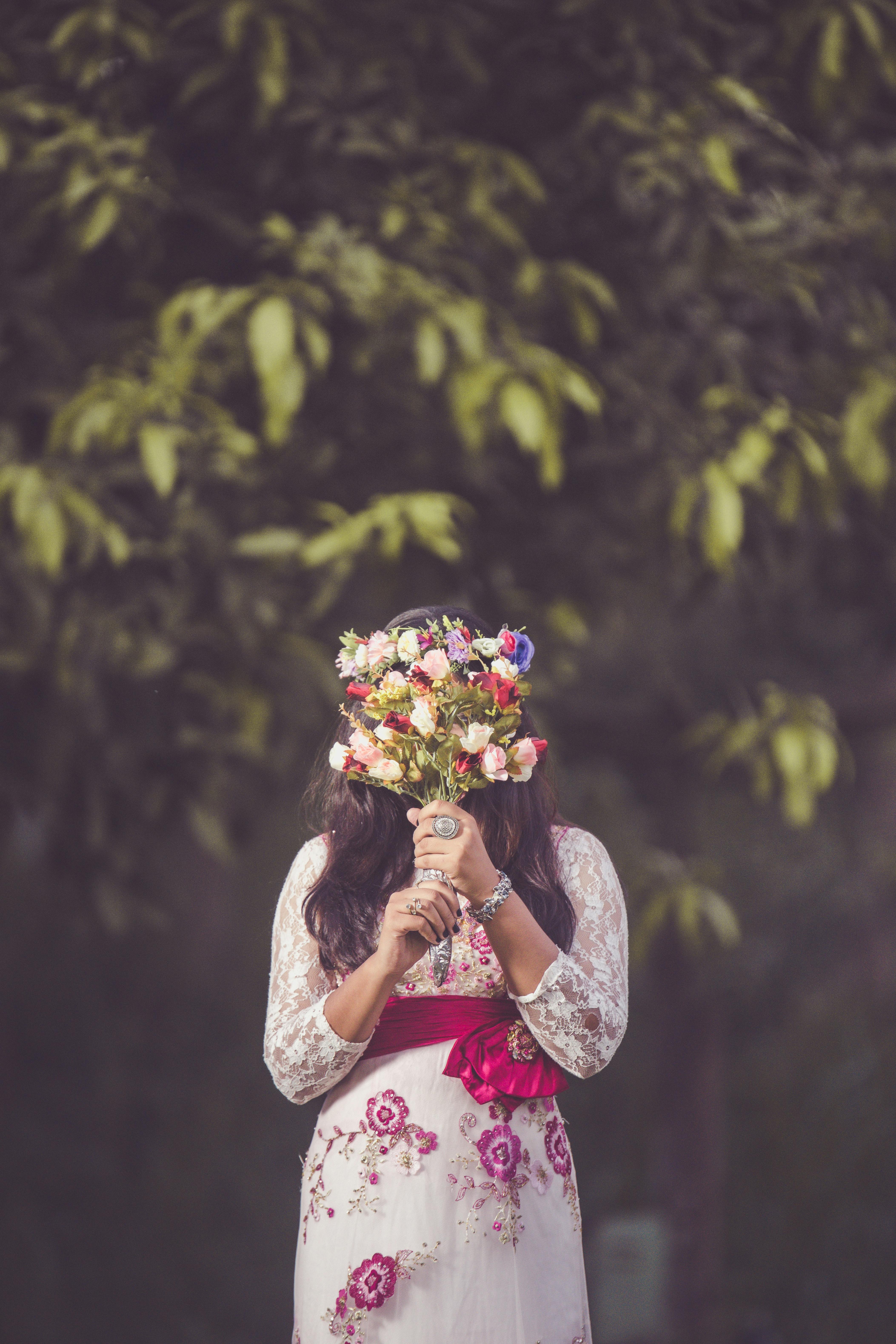Woman Covering Her Face with the Bouquet of Flowers · Free Stock Photo