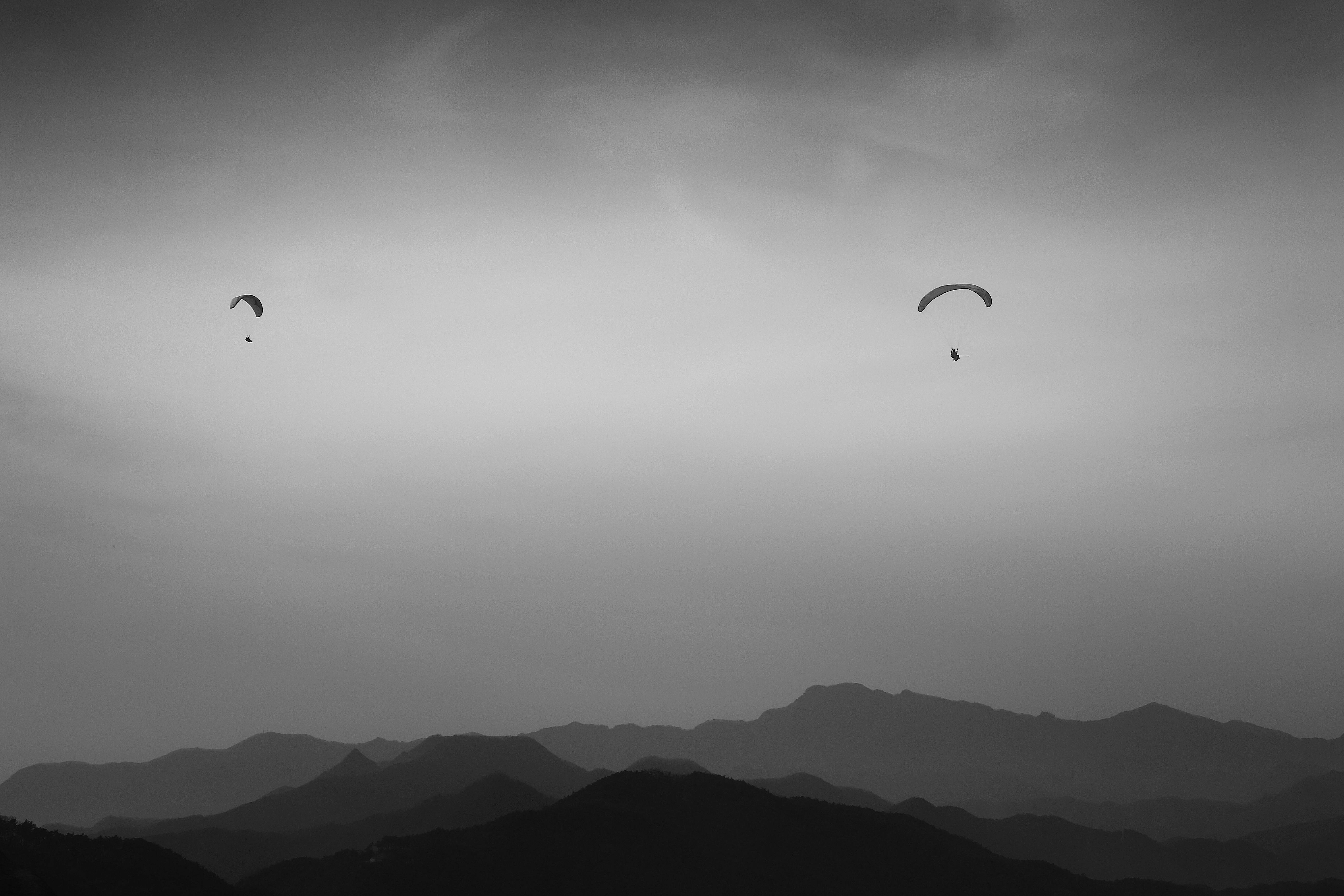 Panorama Photo of a Person Parachuting Above Volcano Lake during ...