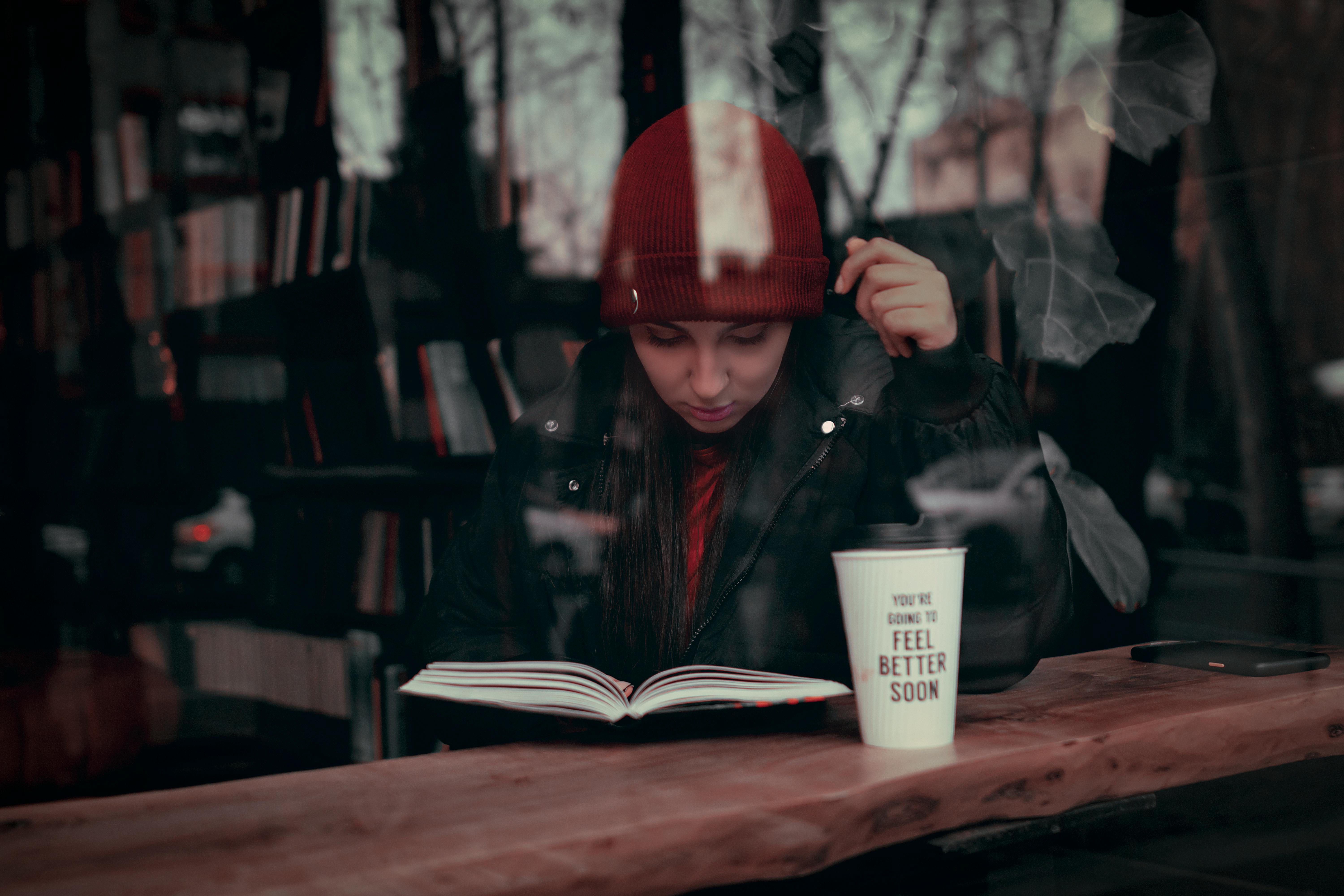 Woman Wearing Red Knitted Beanie Reading a Book · Free Stock Photo