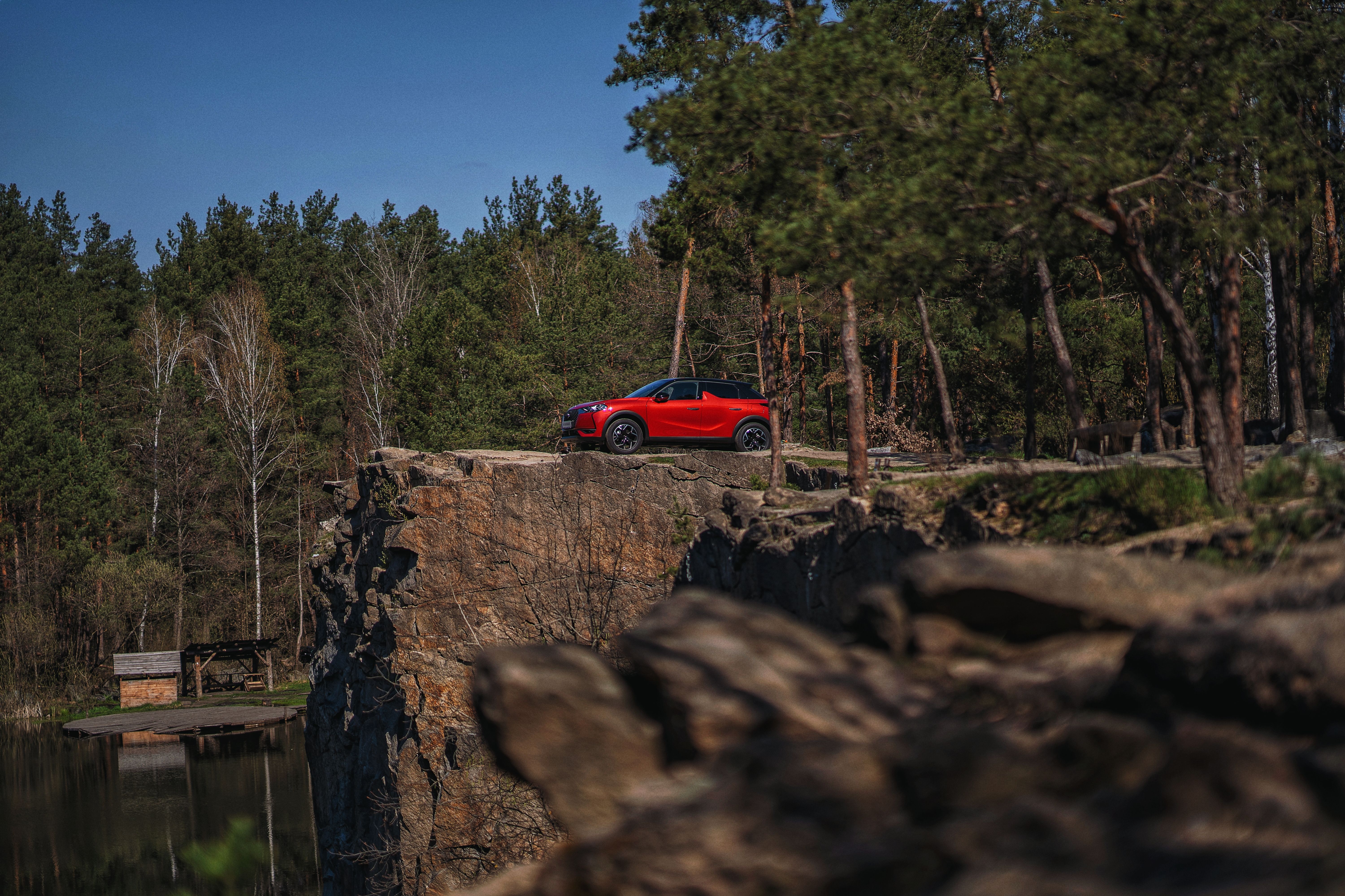 Red Car on Cliff Rock · Free Stock Photo