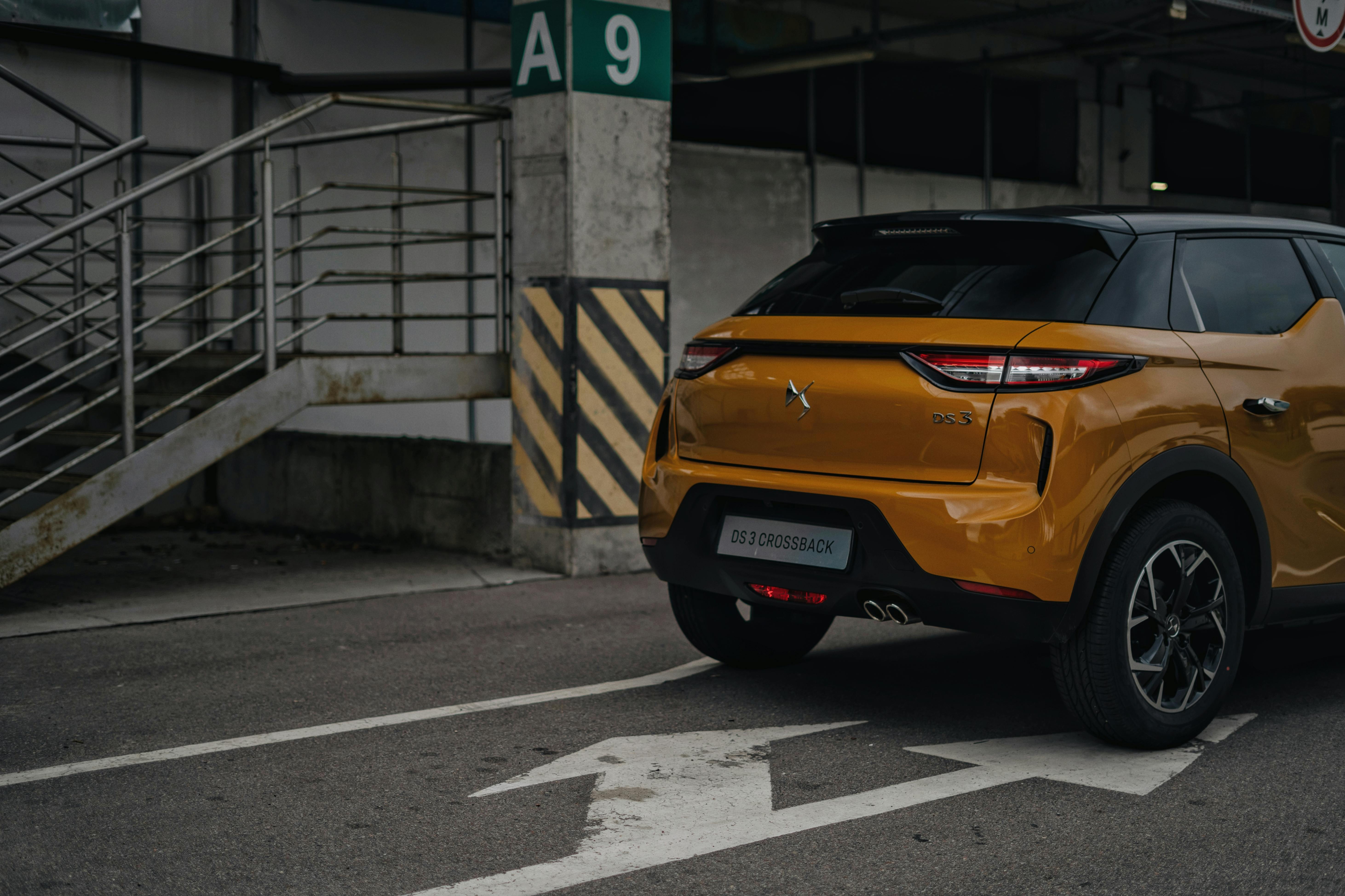 Car Driving Past Hotel with Glowing Neon Sign · Free Stock Photo