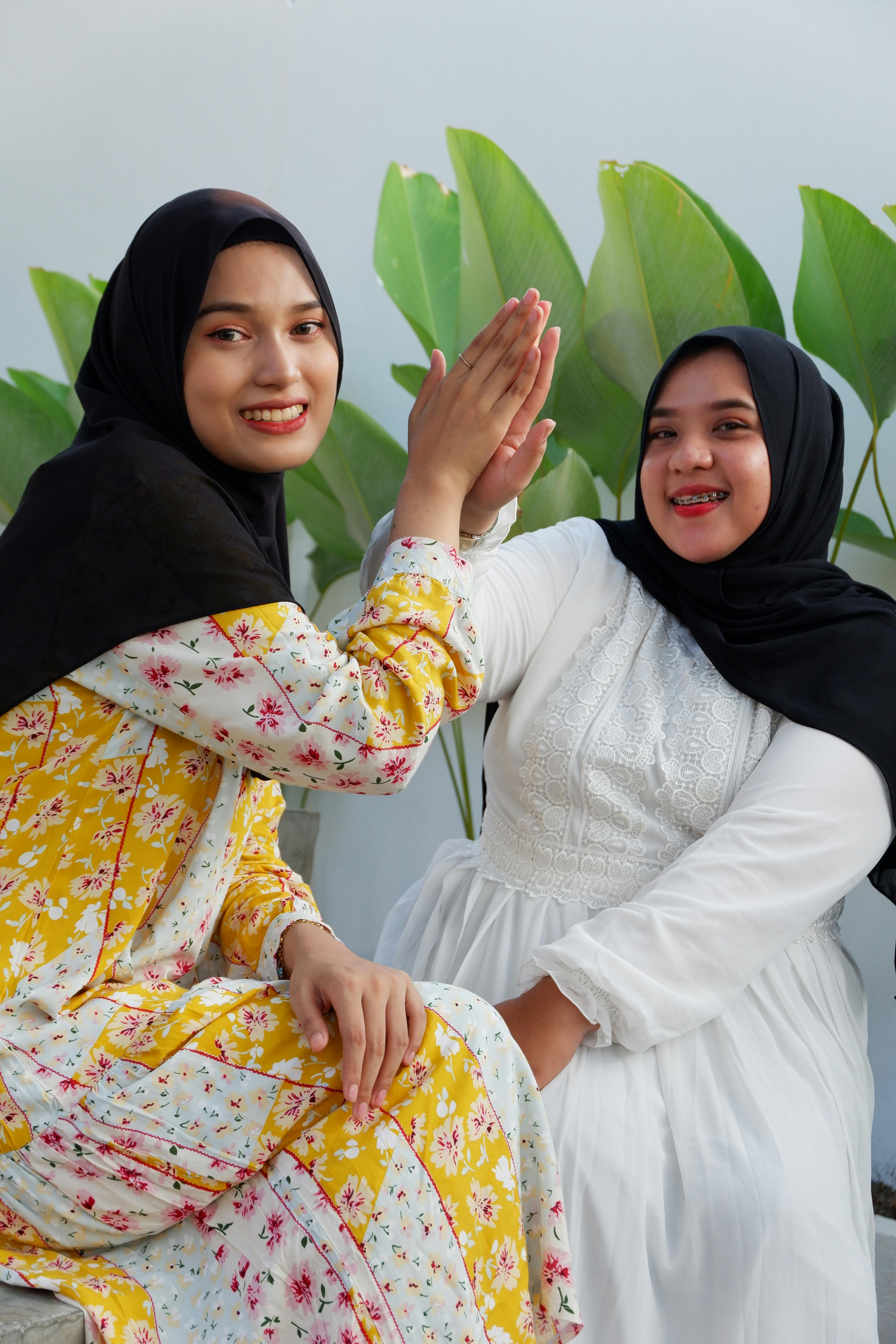 Two Women in Hijab Making a High Five Gesture · Free Stock Photo