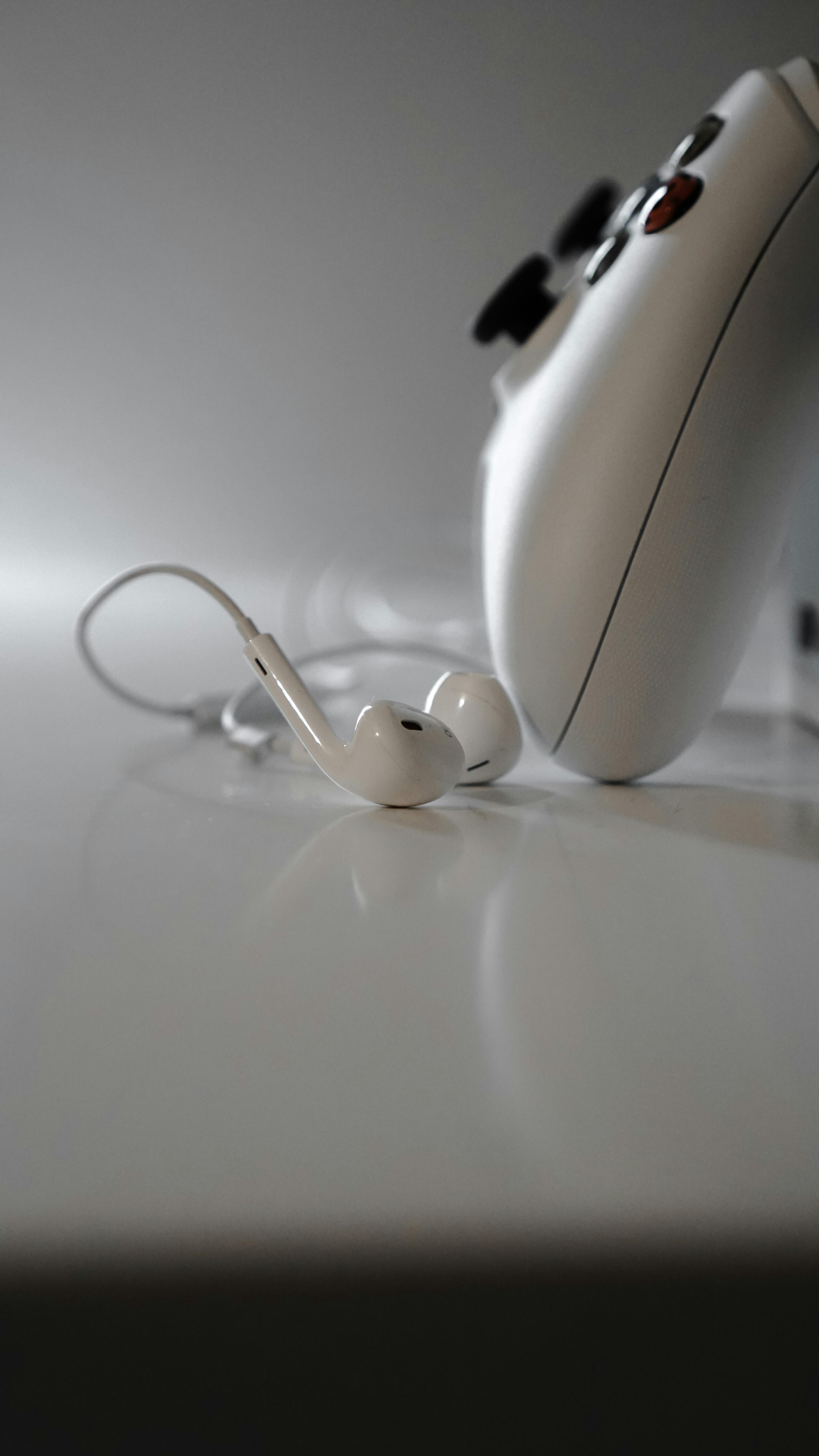 A Close-Up Shot of Black Earbuds · Free Stock Photo