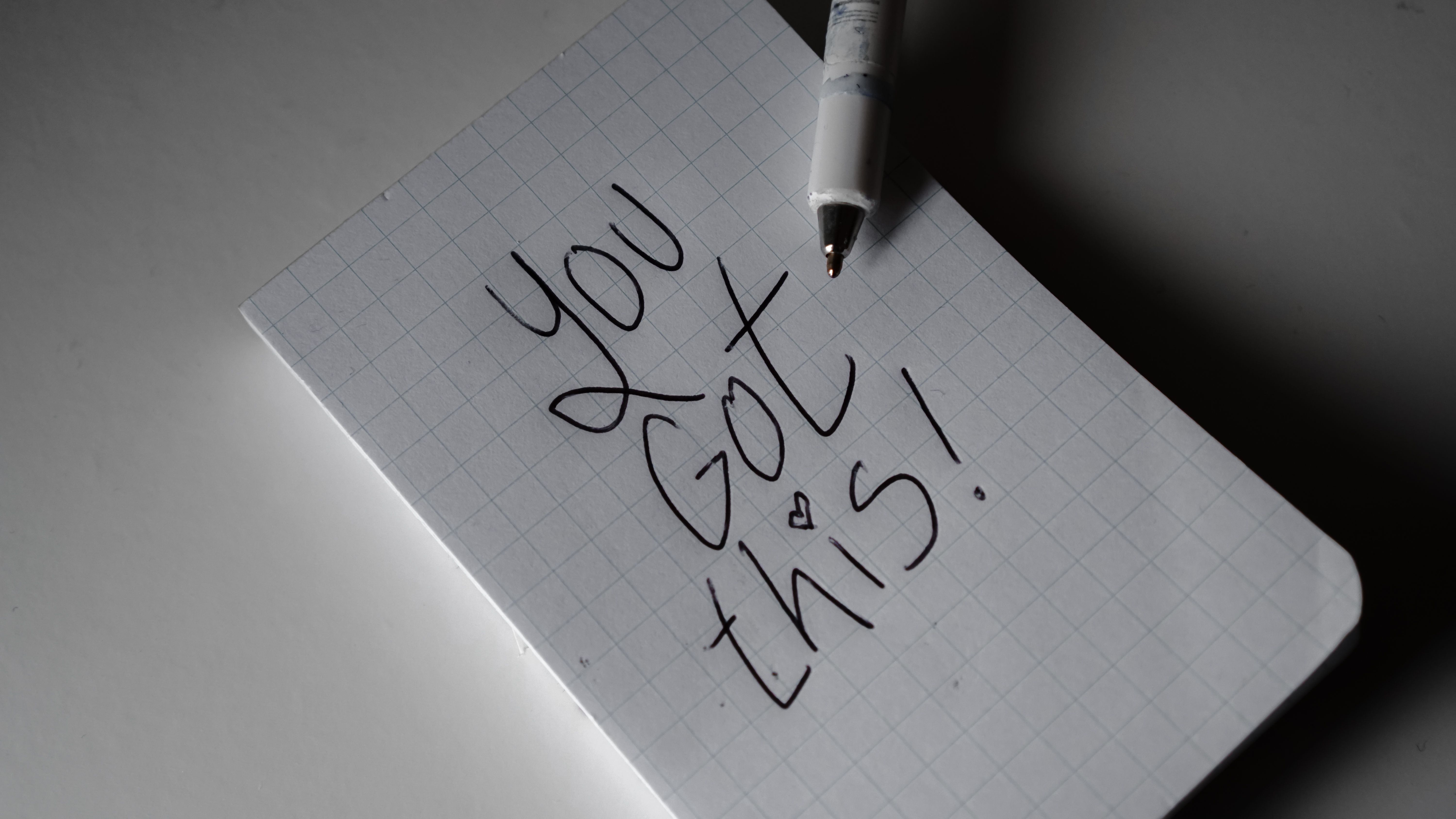 Green and Silver Push Pen on White Ruled Paper Indoors · Free Stock Photo