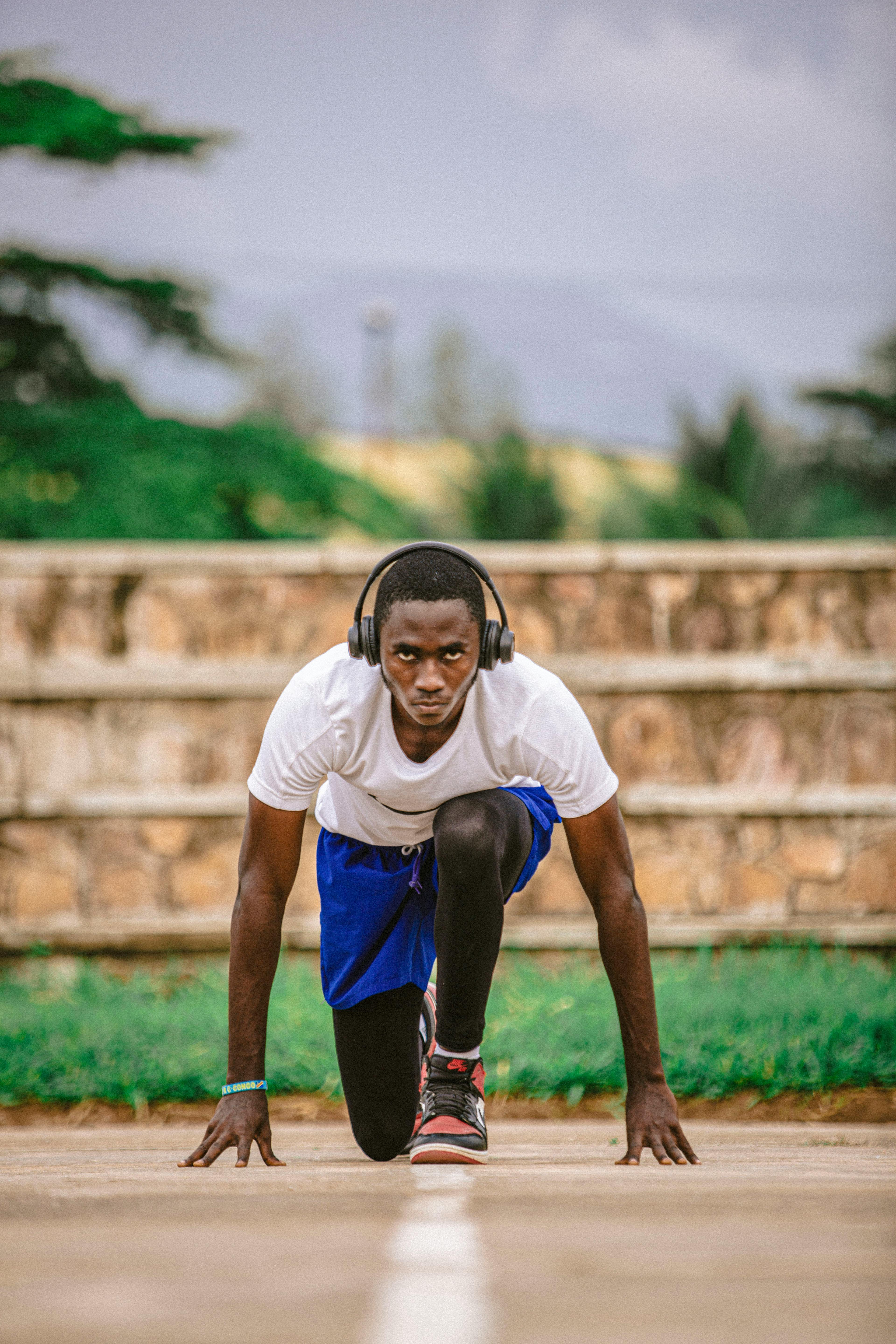 Strong sportsmen ready for running on stadium · Free Stock Photo