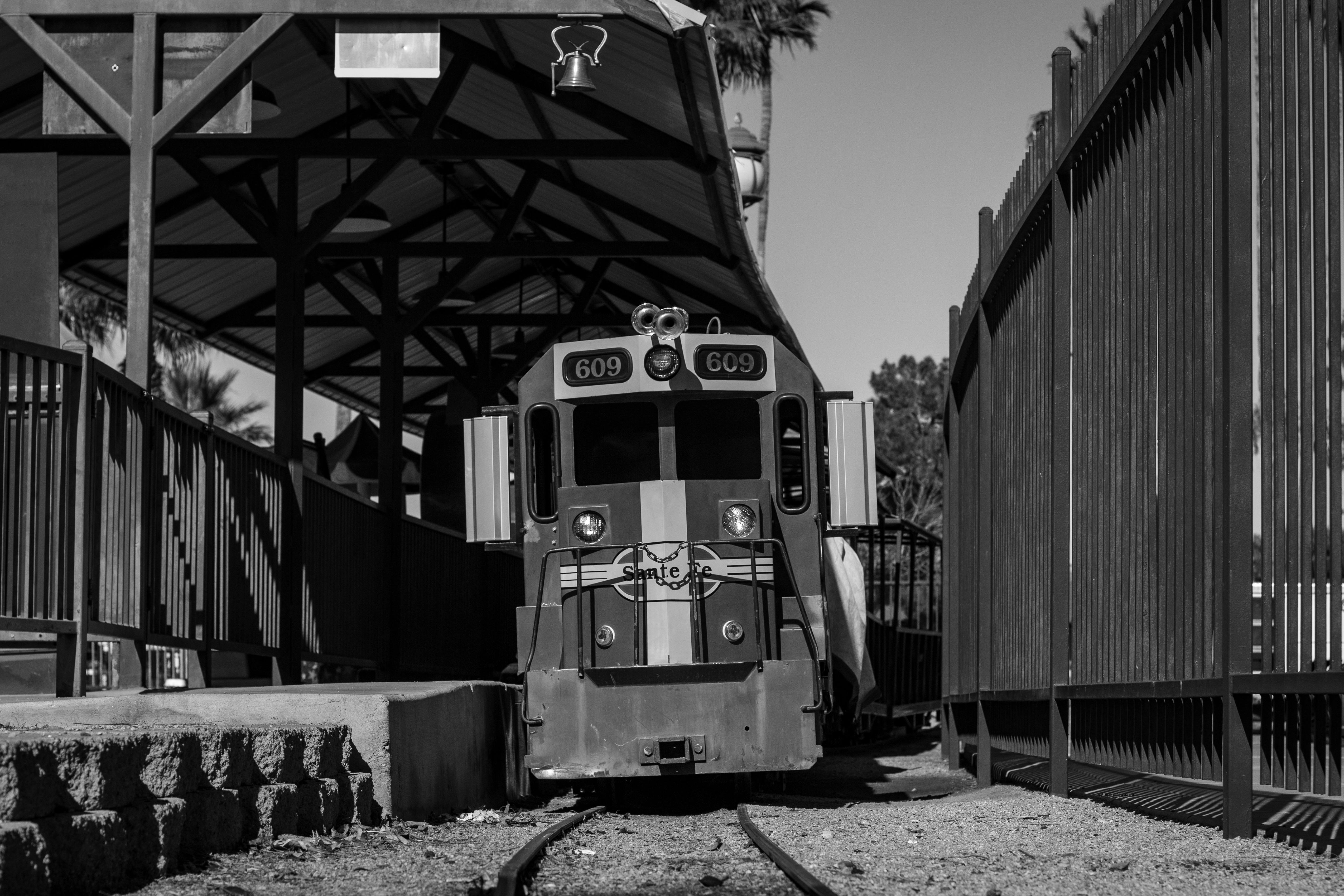 Grayscale Photo of a Train Parked at a Train Station · Free Stock Photo